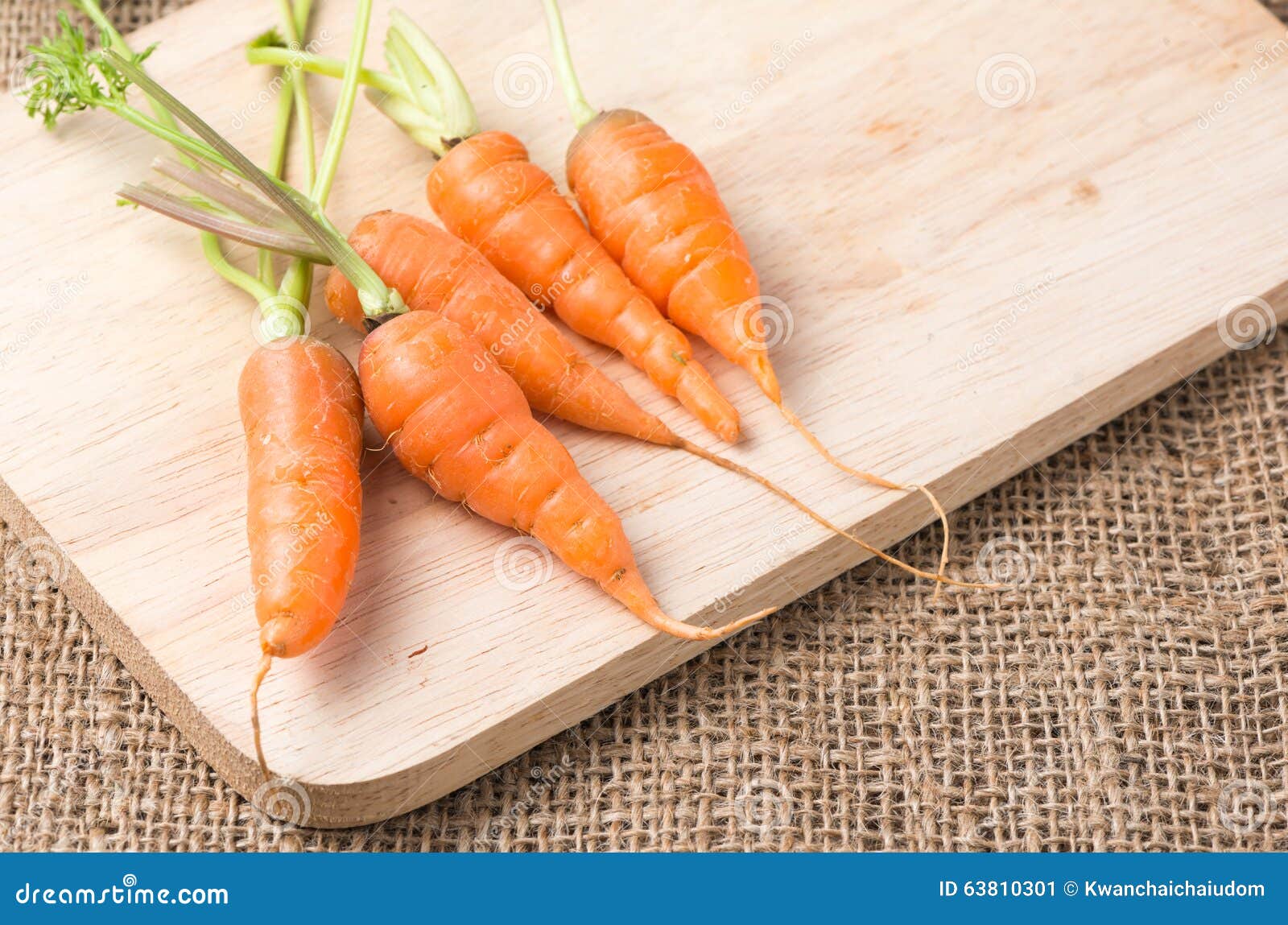 Small Carrots on Wood Plate Stock Image - Image of large, natural: 63810301