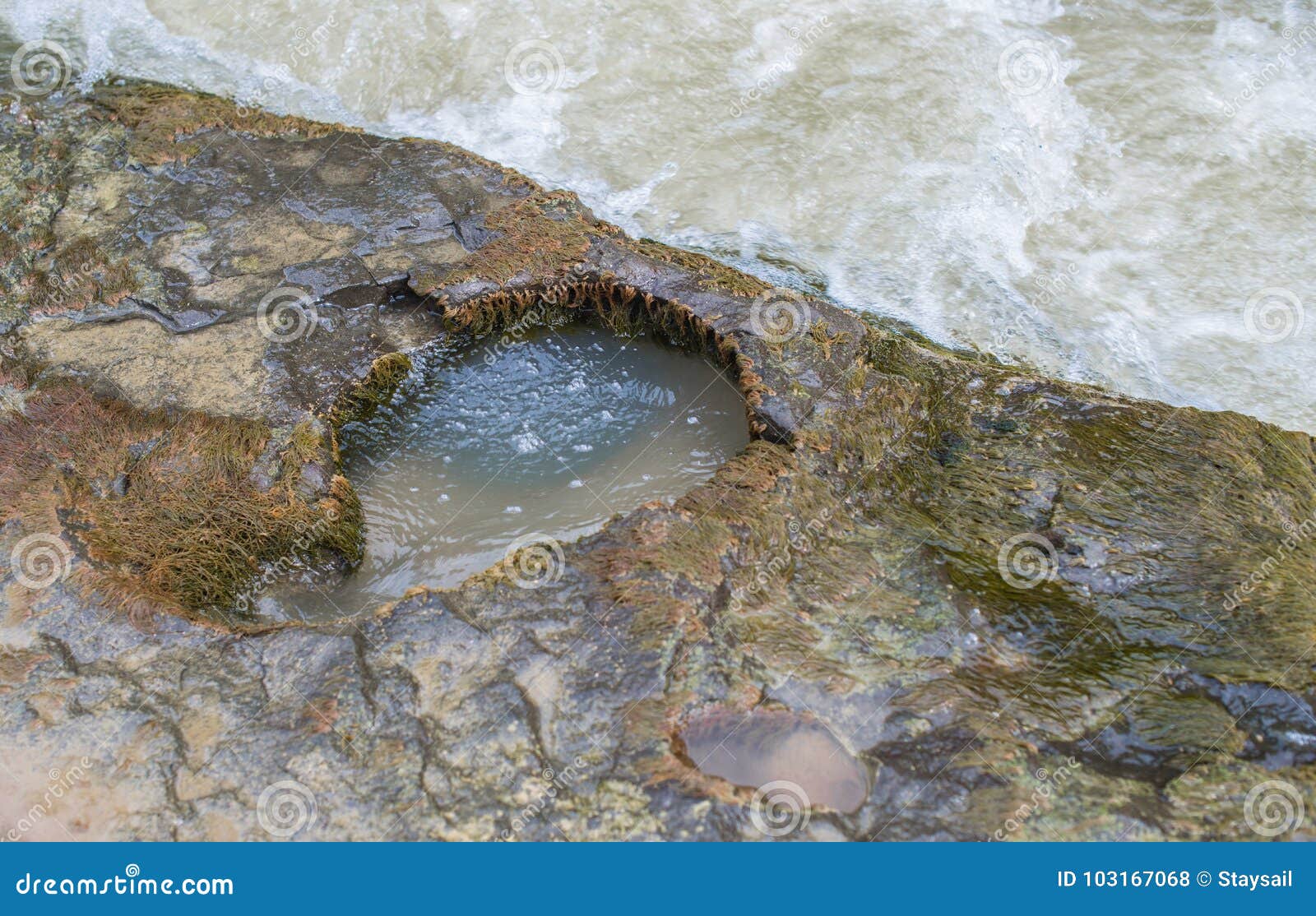 A Small Cave in the River Carved the Rocky Shore Stock Photo - Image of ...