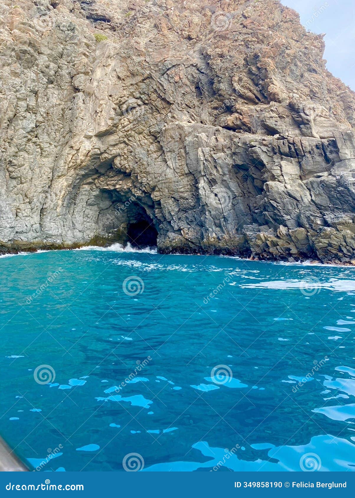 A Small Cave in a Stone Cliff Stock Photo - Image of shore, clear ...