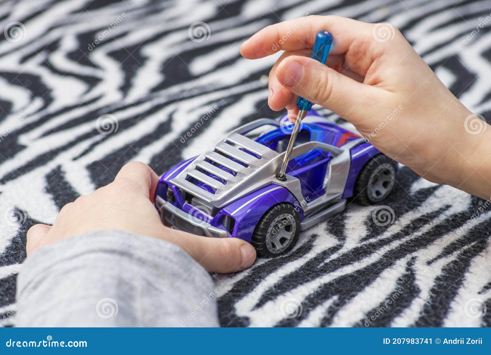 Small Child Boy Holding Screwdriver Fixing Broken Toy. a Boy Fixing Toy ...