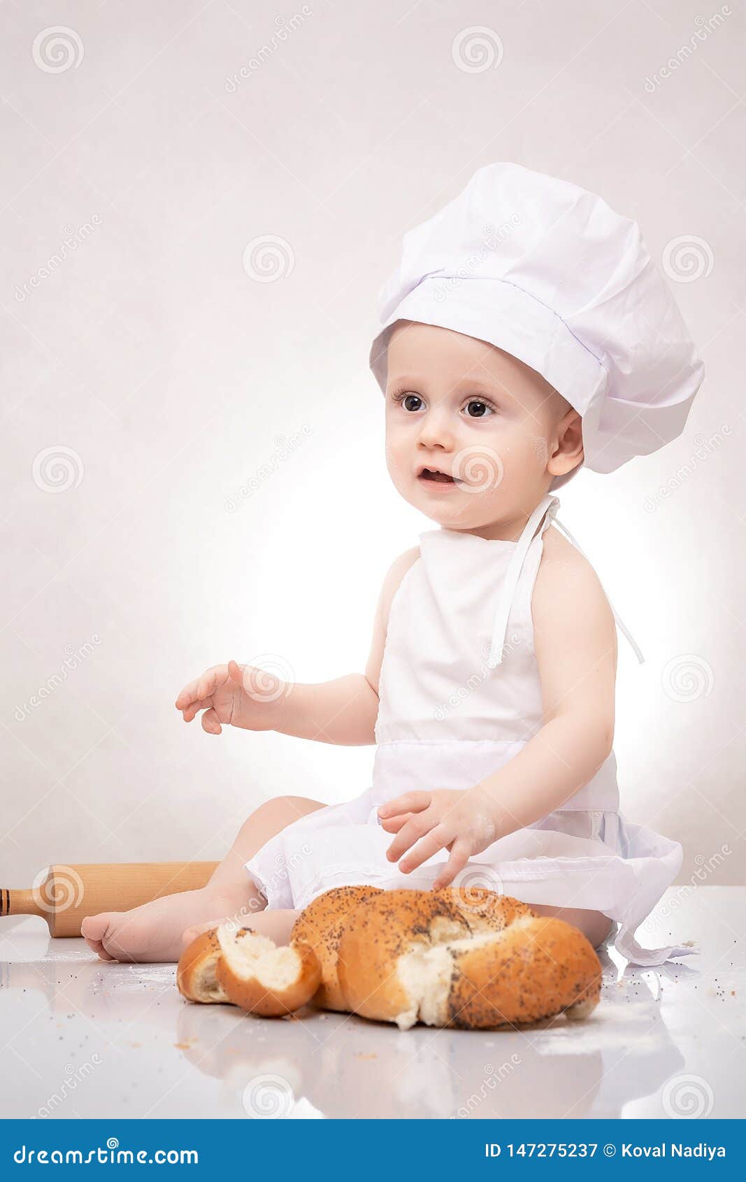 Small Child Cooks a Croissant with Bread. Laughing Happily Stock Image ...
