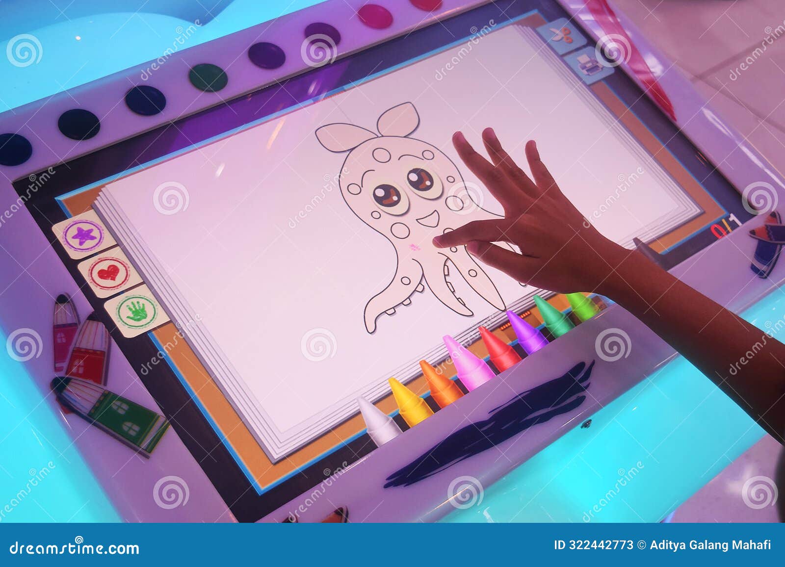 A Small Child is Drawing and Coloring a Picture of Squid Using a Game ...