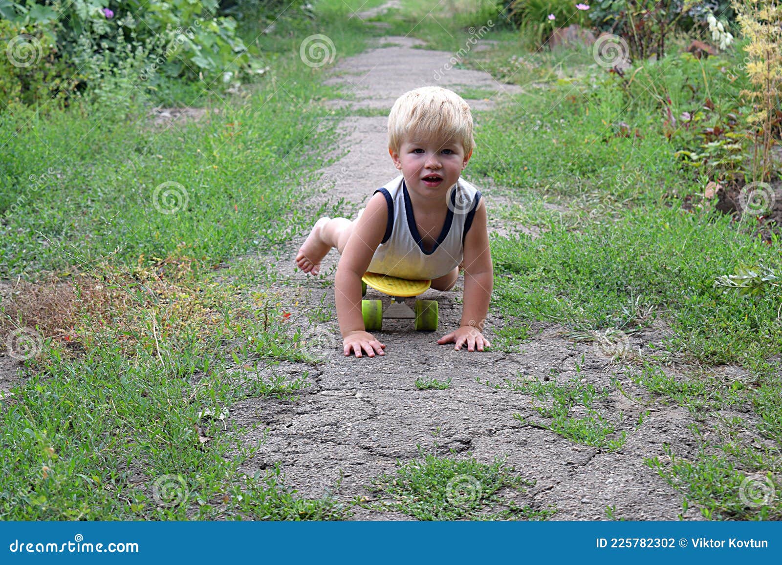 A Small Child is Riding a Skateboard Lying Down Stock Photo - Image of ...