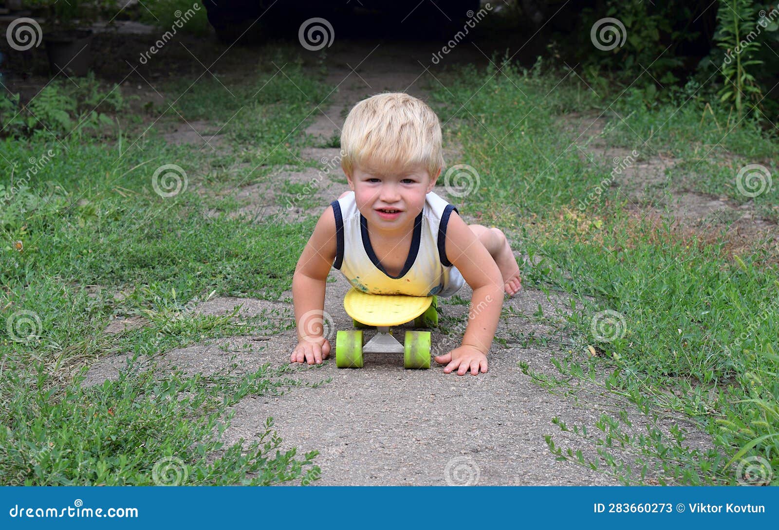 A Small Child is Riding a Skateboard Lying Down Stock Image - Image of ...