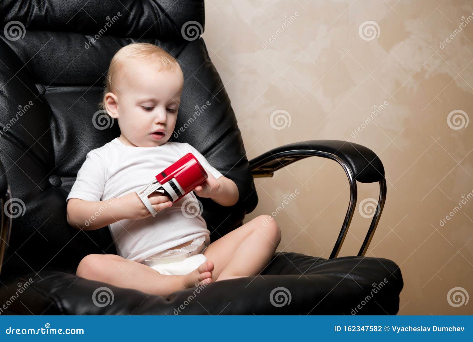 Child Sits in an Office Chair and Plays with Text Stamp Stock Photo ...