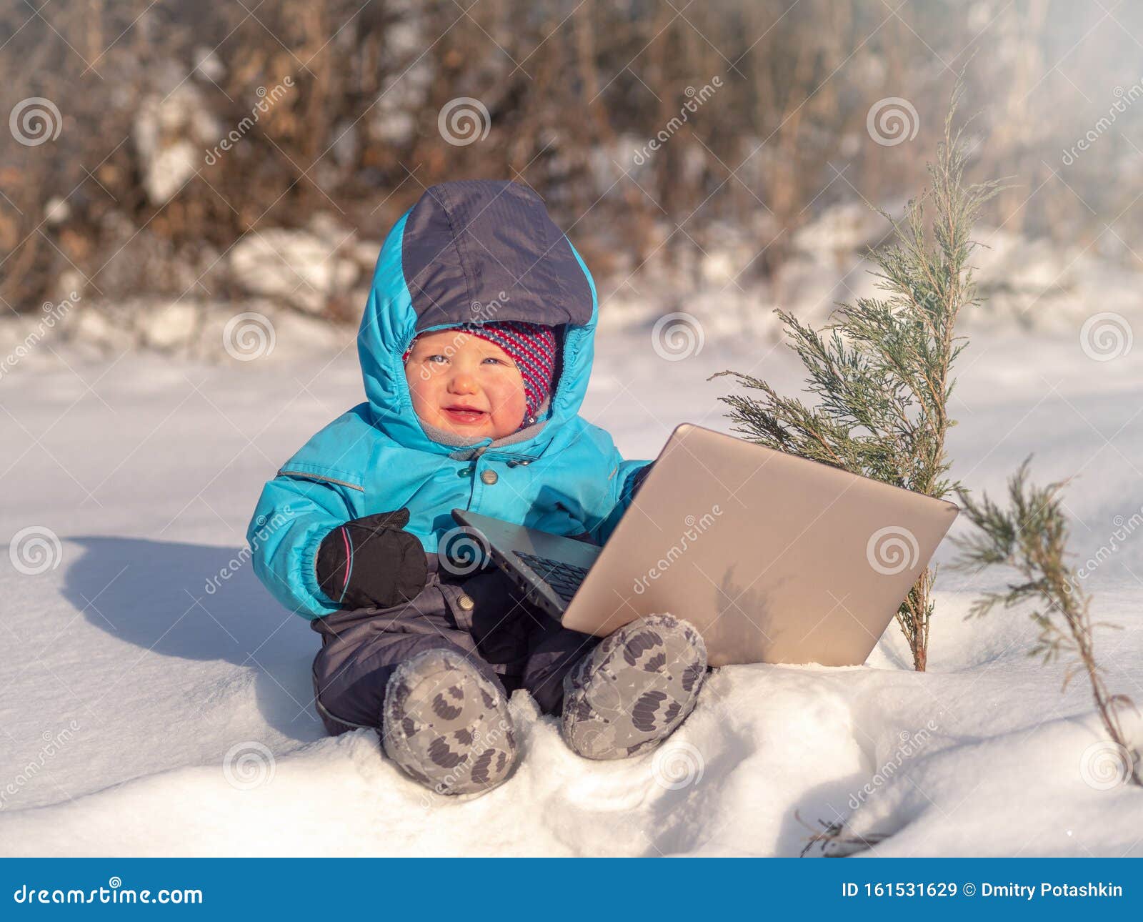A Small Child Sits in the Snow with a Laptop Stock Image - Image of ...