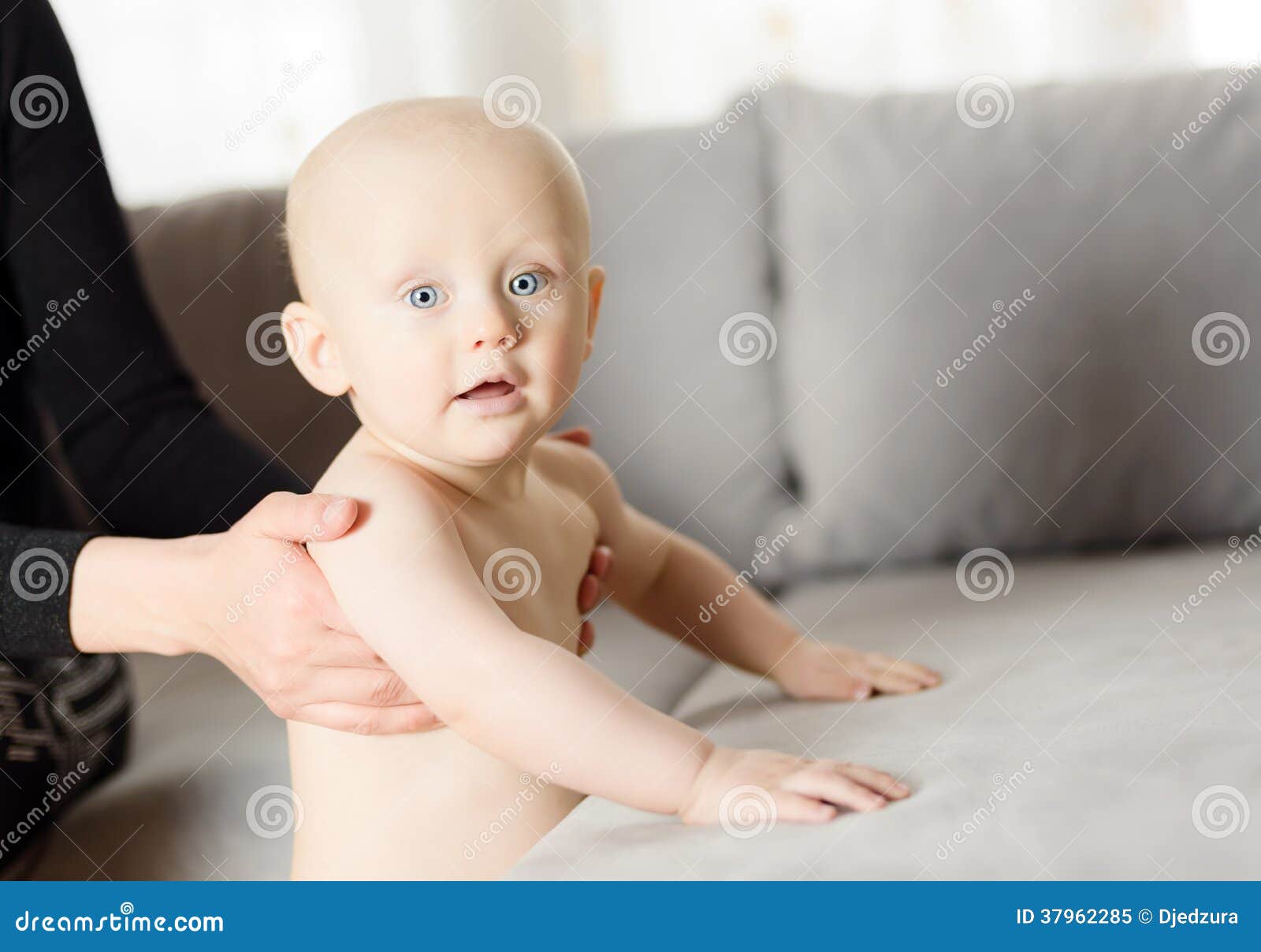 Small Child Standing by the Sofa in the Living Room Stock Image - Image ...