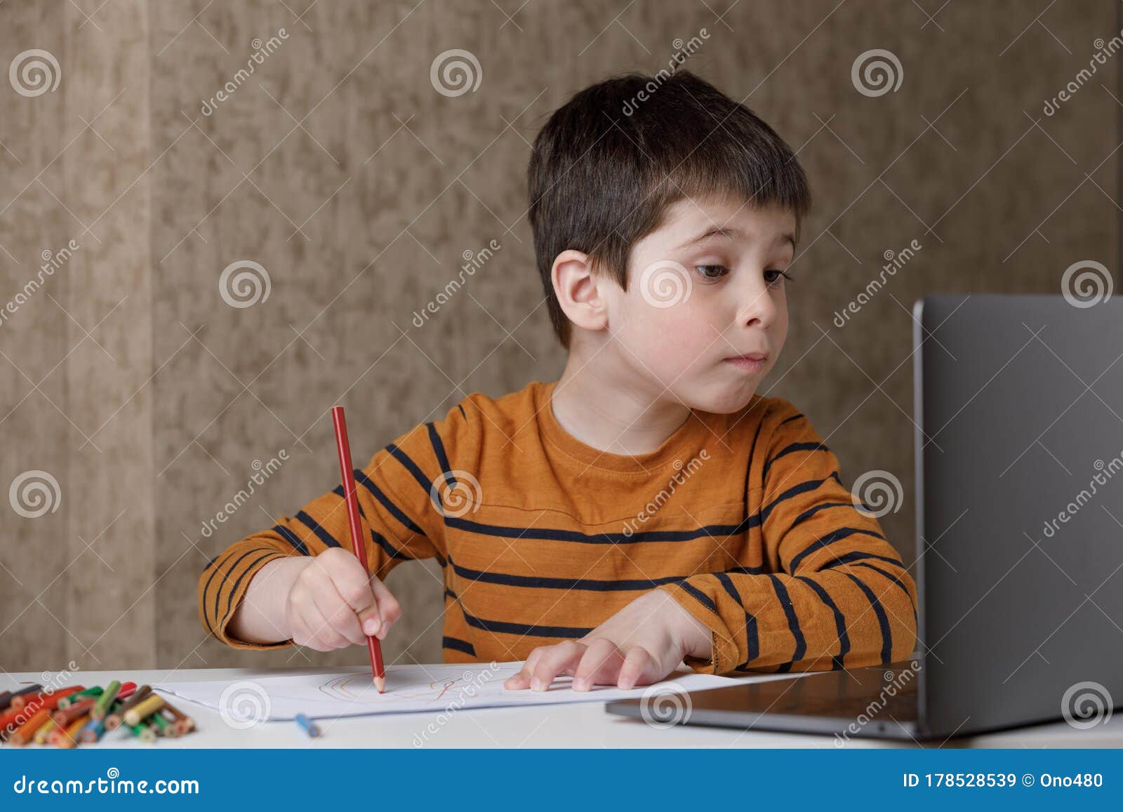A Small Child is Studying at the Computer. Distance Learning at Home ...
