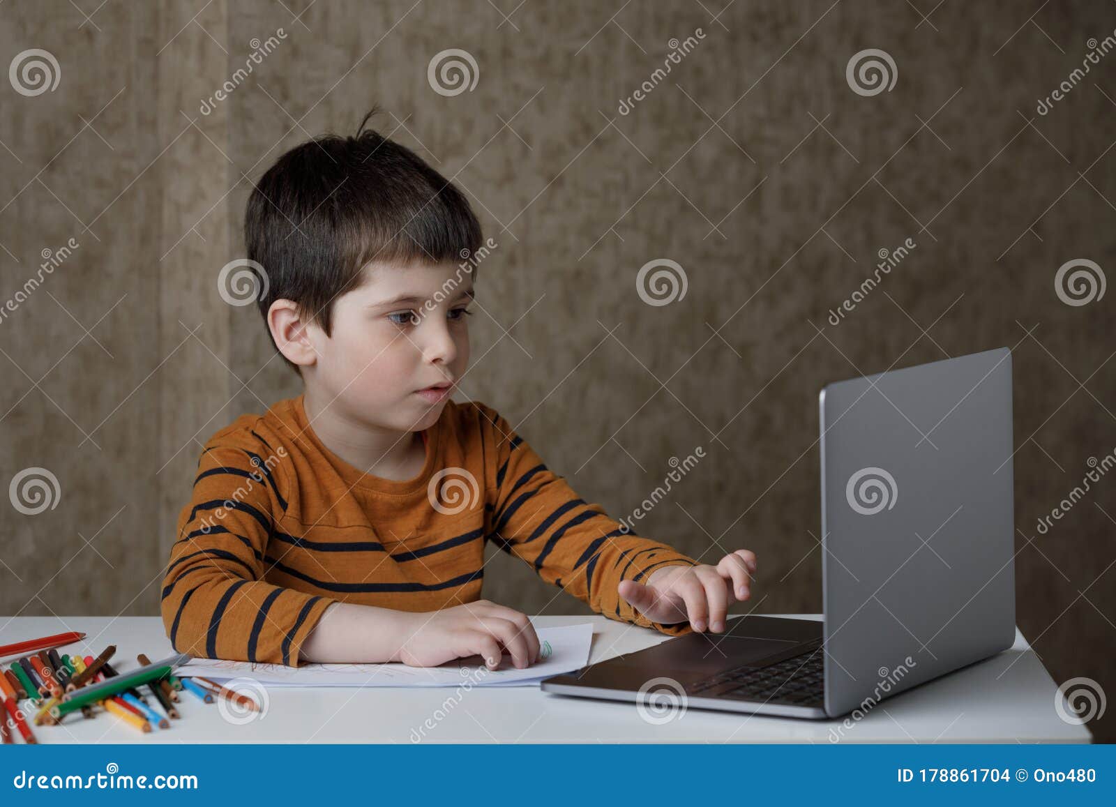 A Small Child is Studying at the Computer. Distance Learning at Home ...