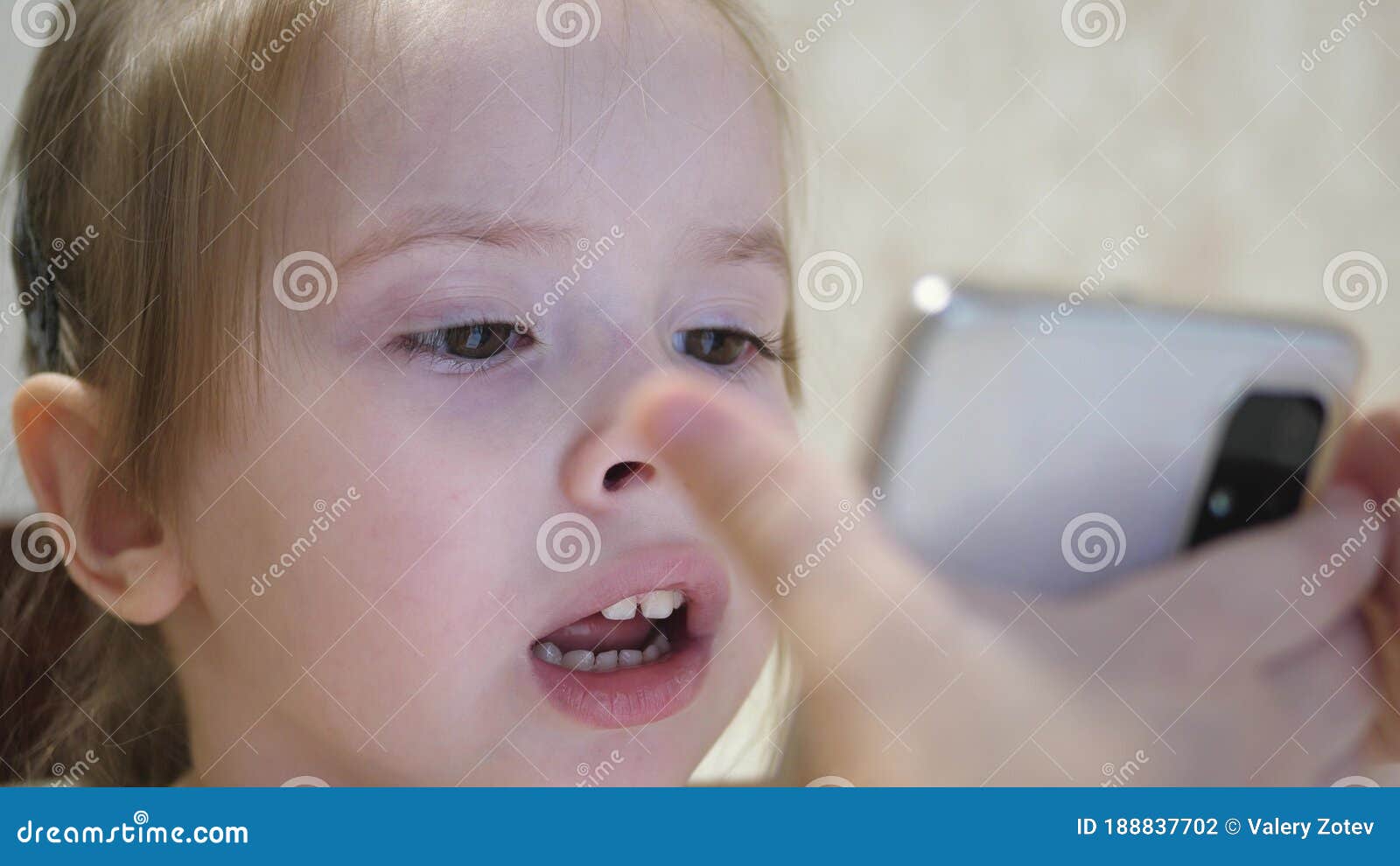 A Small Child is Talking on the Phone Via Video Calling. Kid ...