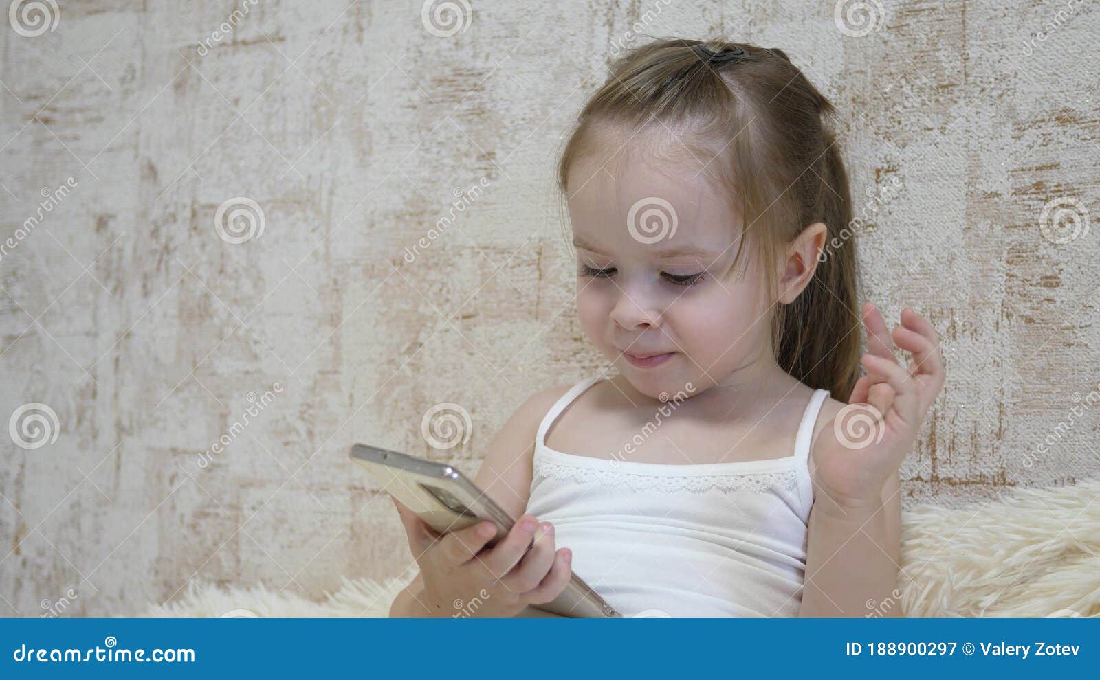 A Small Child is Talking on the Phone Via Video Calling. Kid ...
