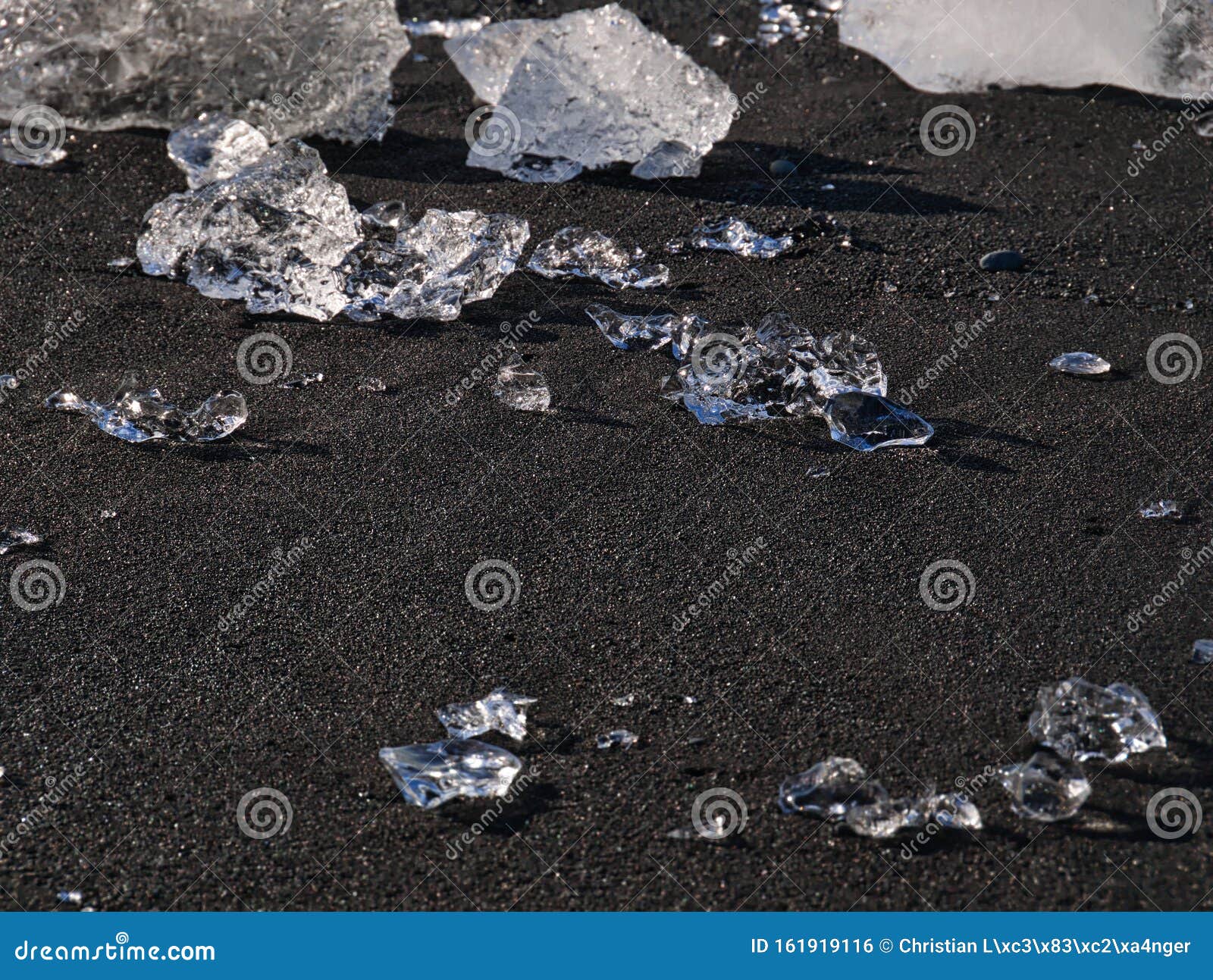 Small Chunks of Ice Sparkle on the Black Sand Stock Photo - Image of ...