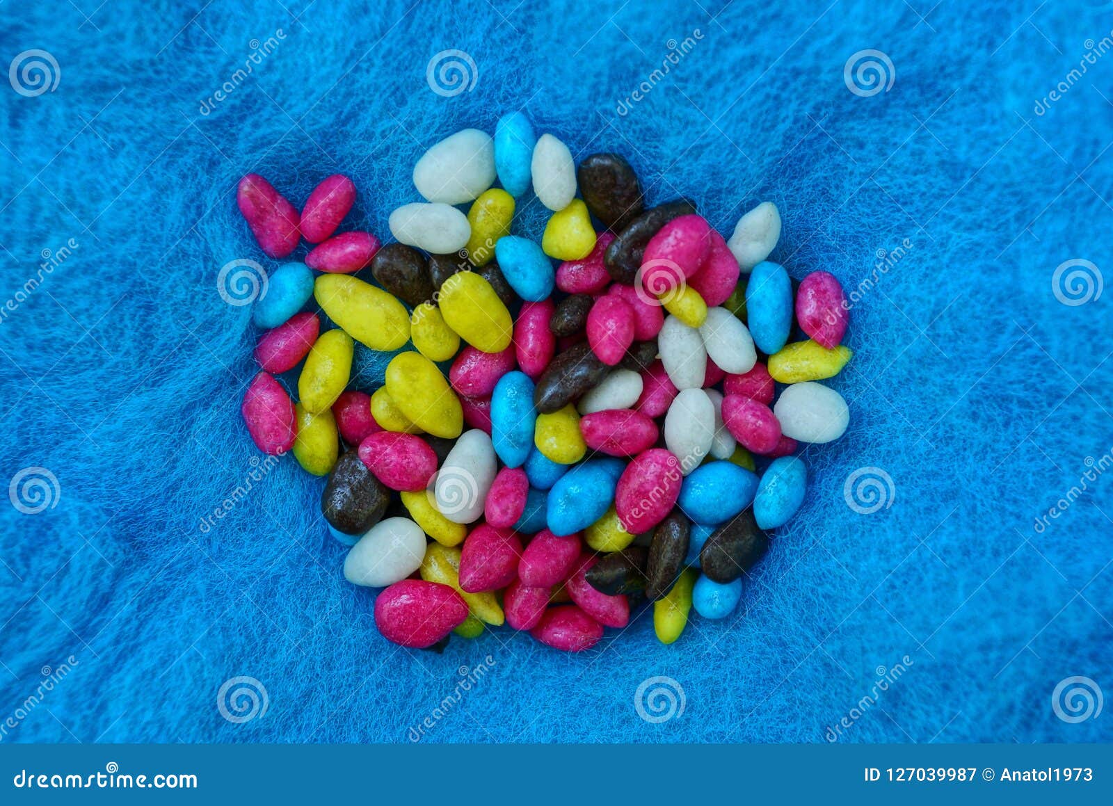 Small Colored Candy Pebbles in a Pile on Blue Cloth Stock Image - Image ...