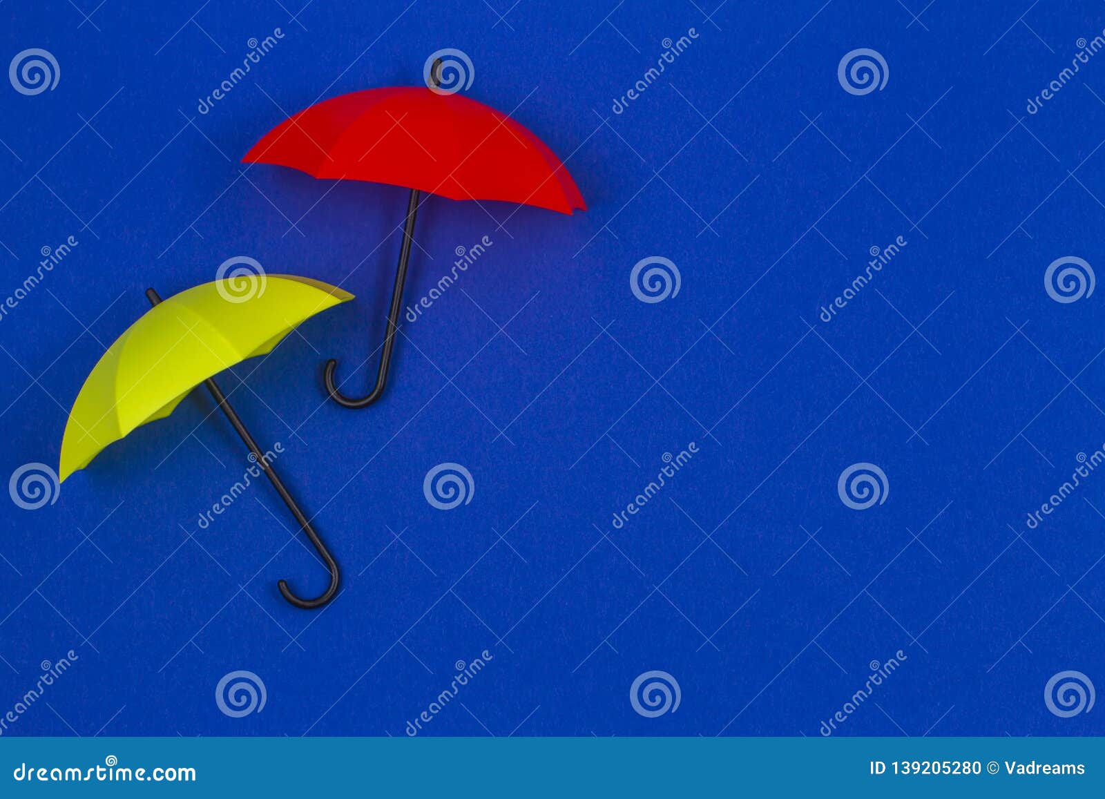 Small Colorful Umbrellas on Blue Color Background Stock Photo - Image ...