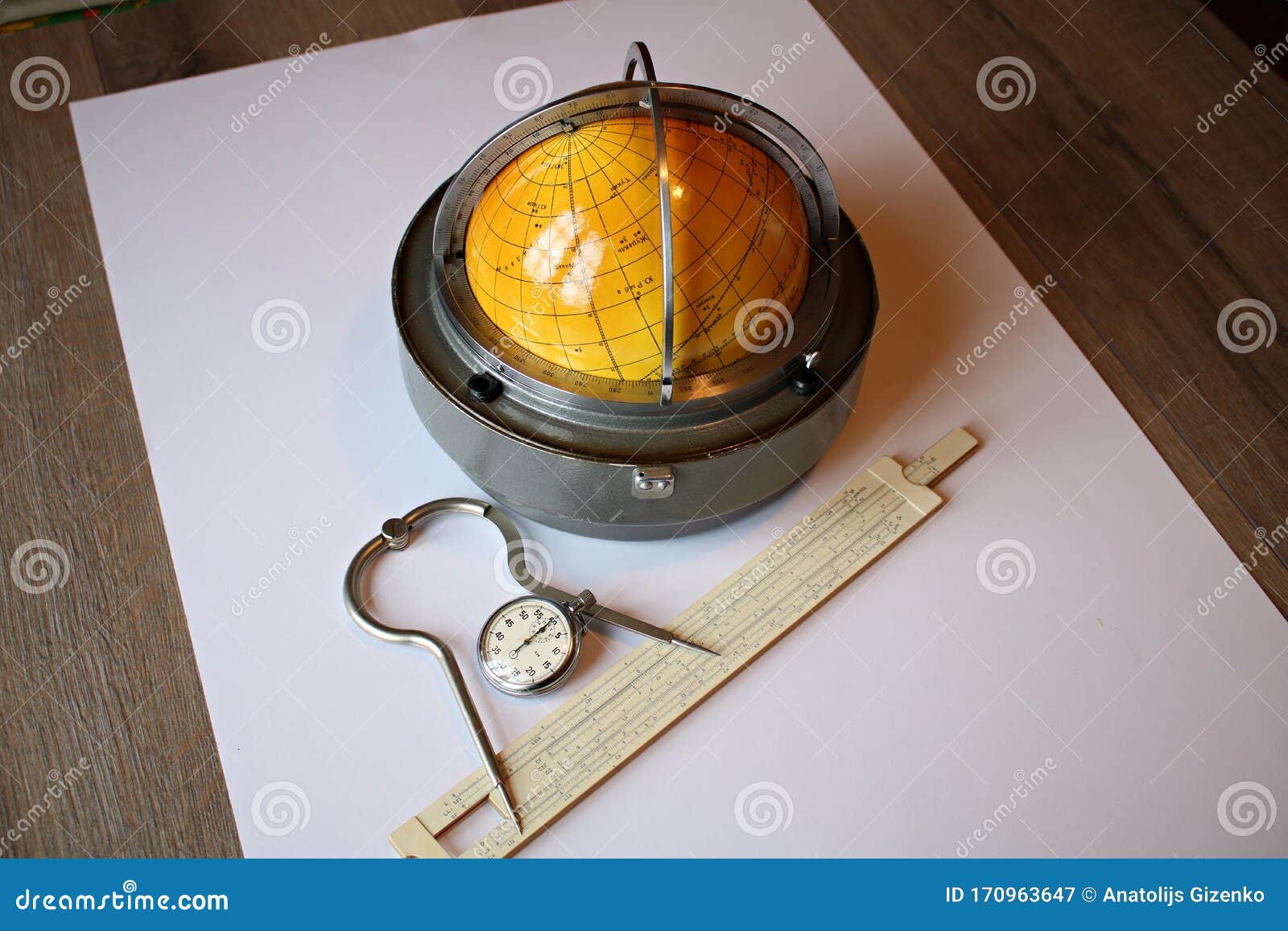 Small Compact Boat Sphere, Gauge, Stopwatch and Slide Rule on the Table ...