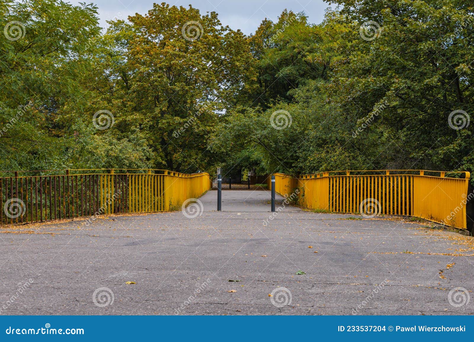 Small Concrete Bridge with Yellow Railings and Trees Around Stock Photo ...