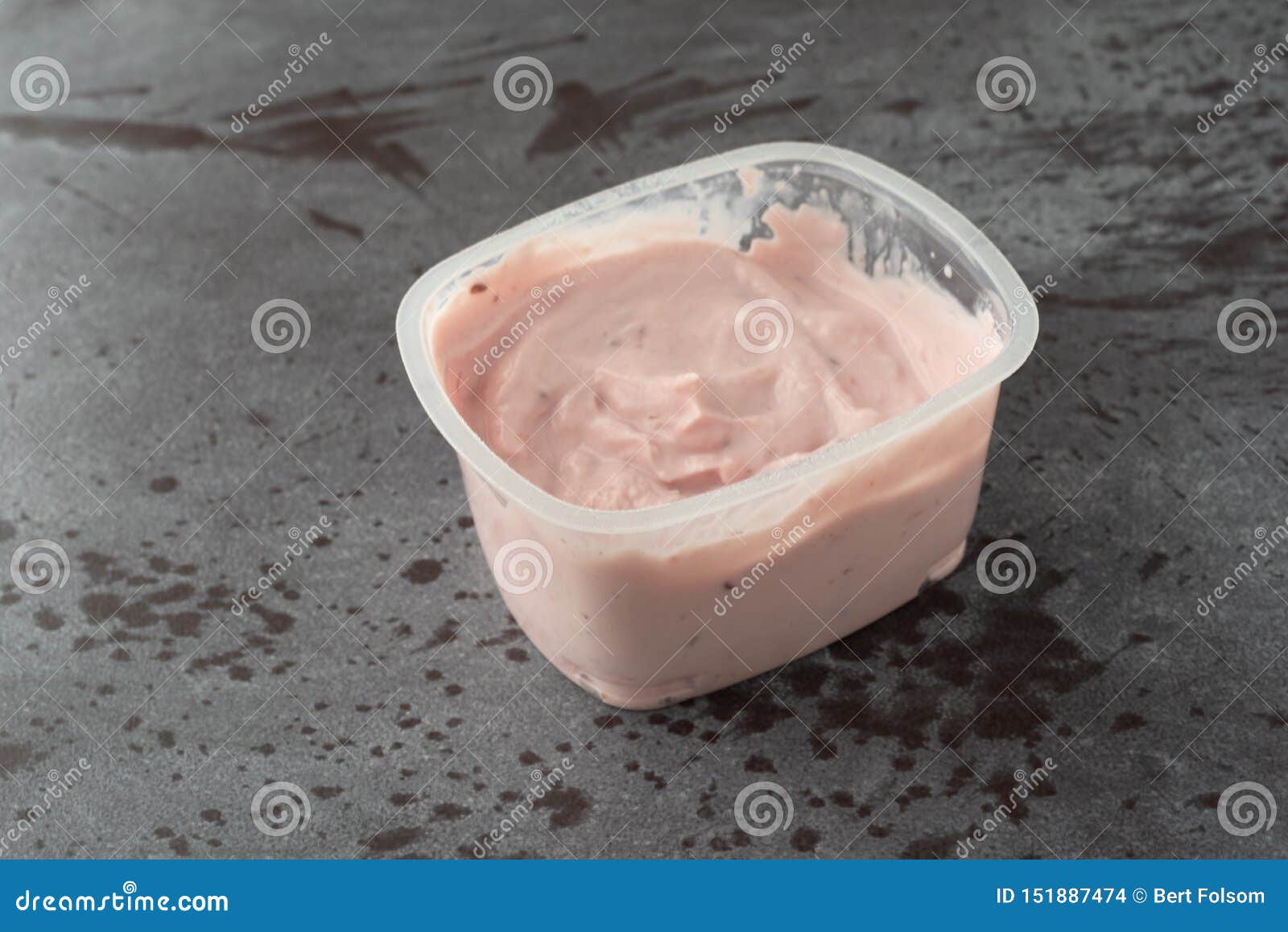 Small Container of Red Raspberry Yogurt on a Gray Background Side View ...