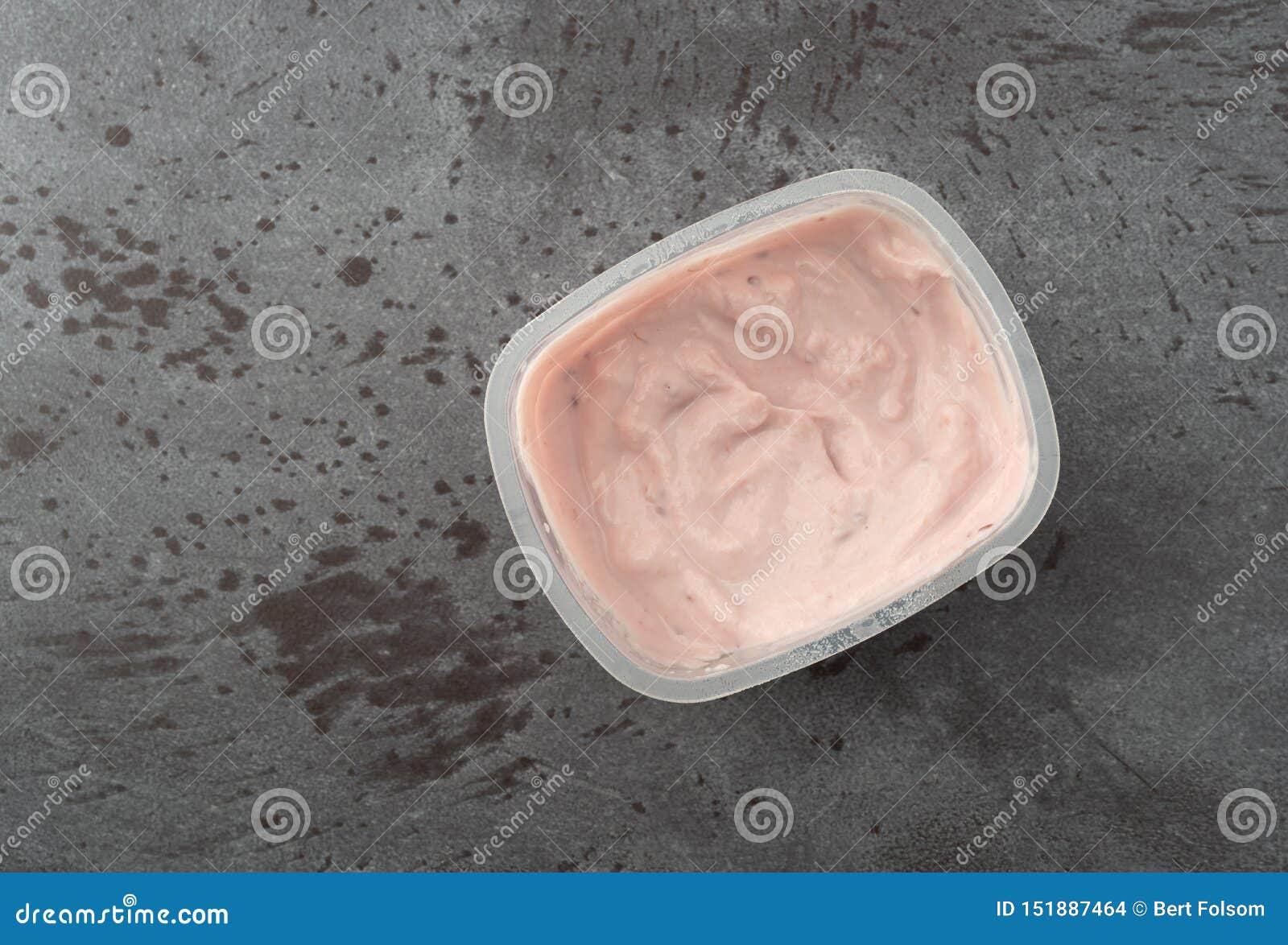 Small Container of Red Raspberry Yogurt on a Gray Background Top View ...