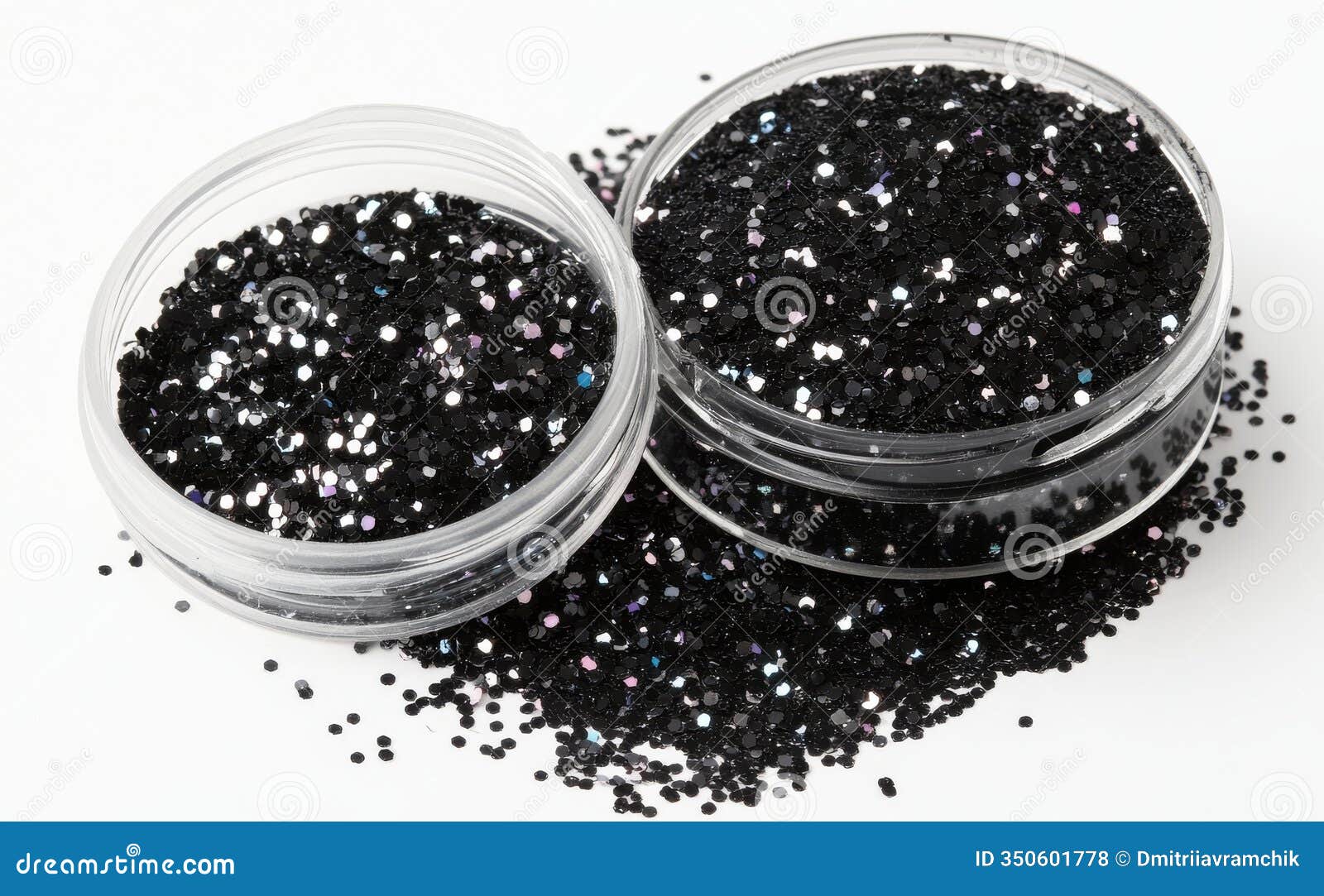 A Small Container of Silver Glitter Spills Onto a White Surface ...