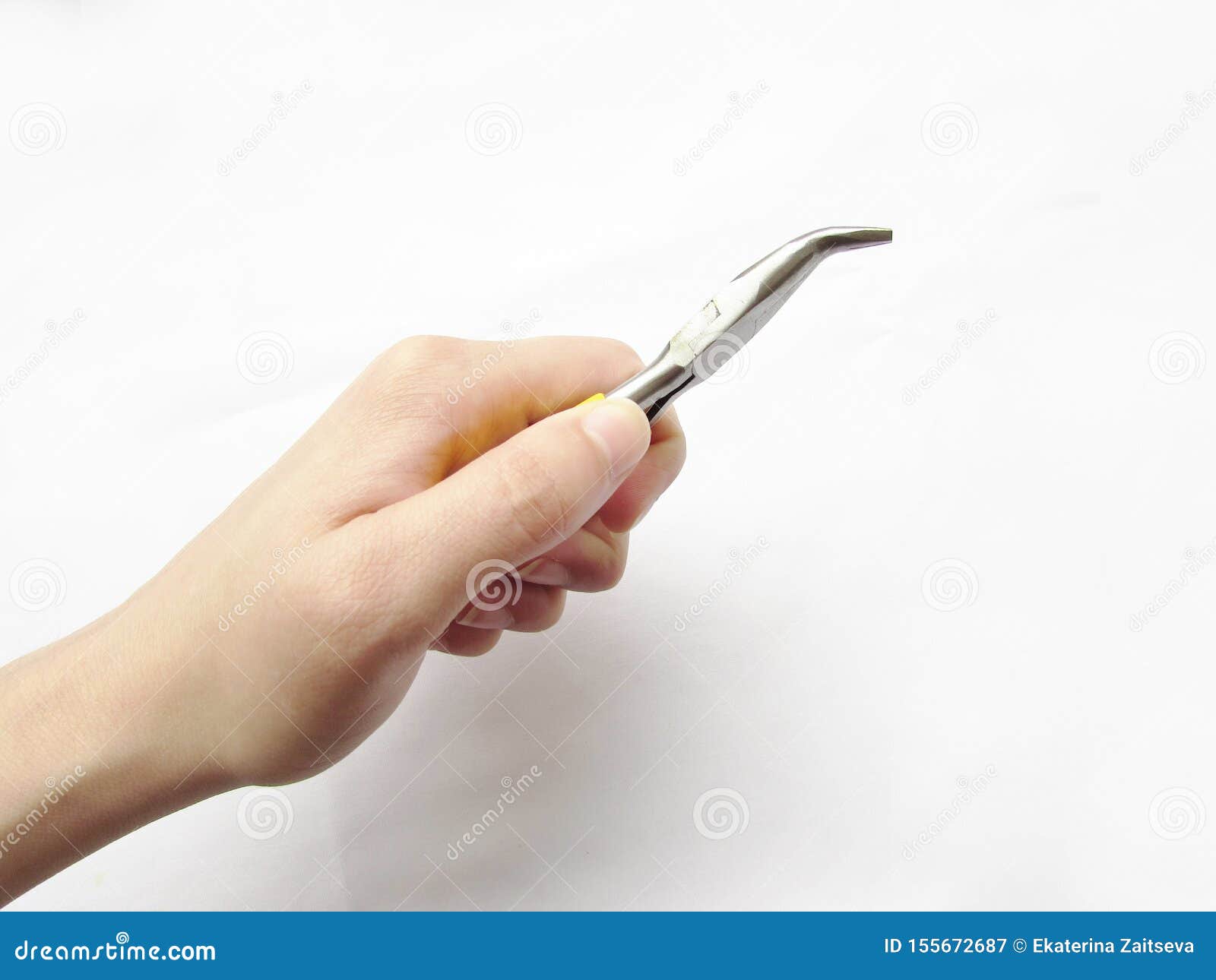 Small Crooked Pliers with Bright Yellow Handles are Squeezed in the ...