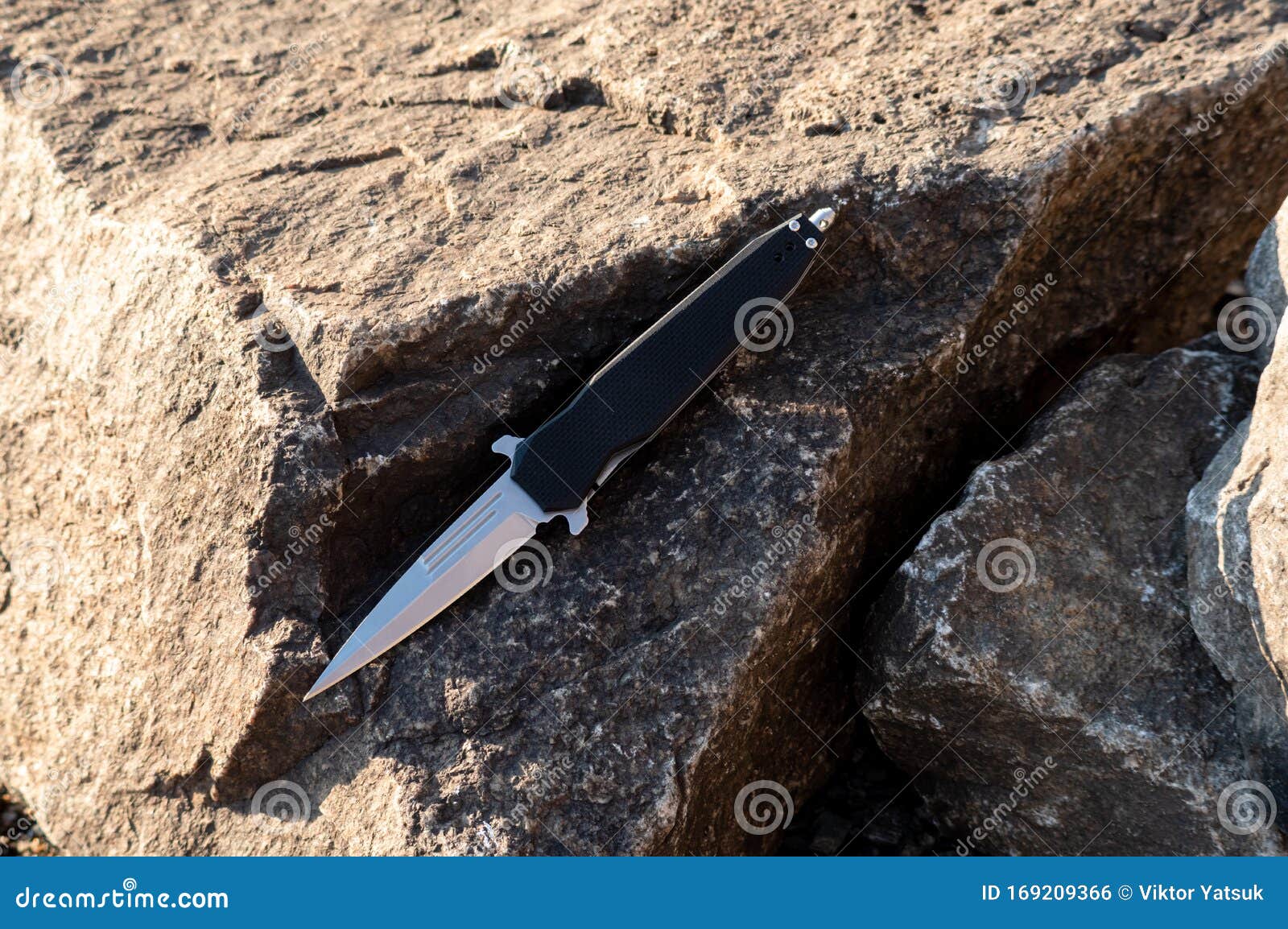 A Small Dagger Against a Stone Background. a Dagger-shaped Knife Stock ...