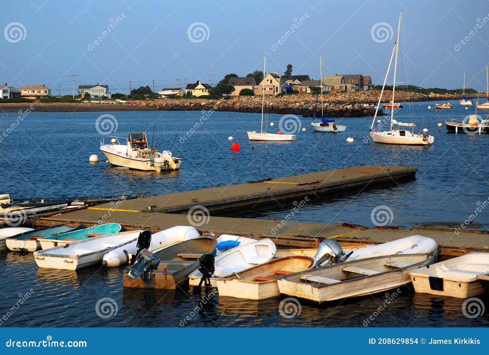 Small Dinghies Line a Pier in a Calm Harbor Stock Photo - Image of ...