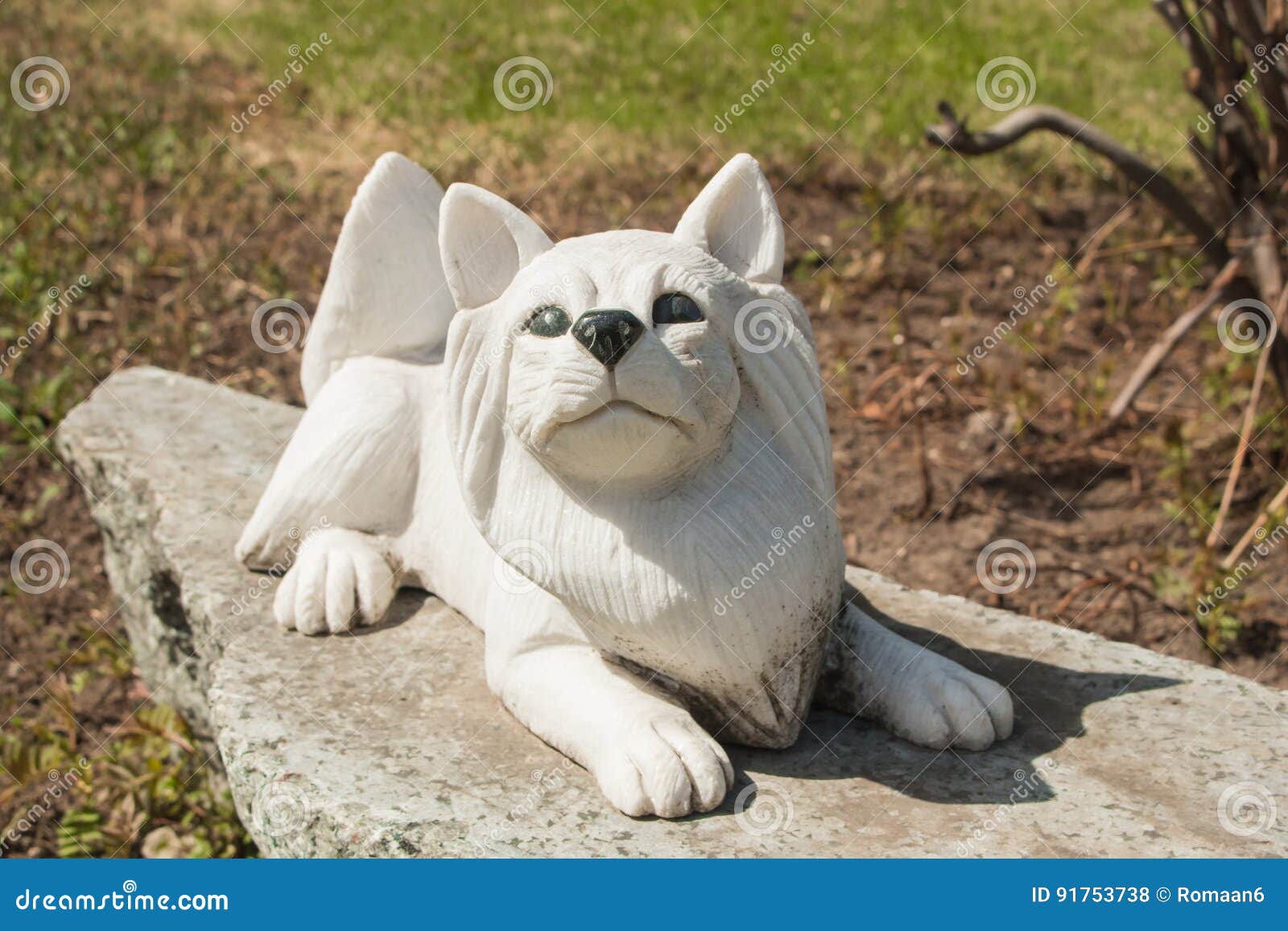 Small Dog Marble Sculpture on Granite Base in Spring Garden Stock Photo ...