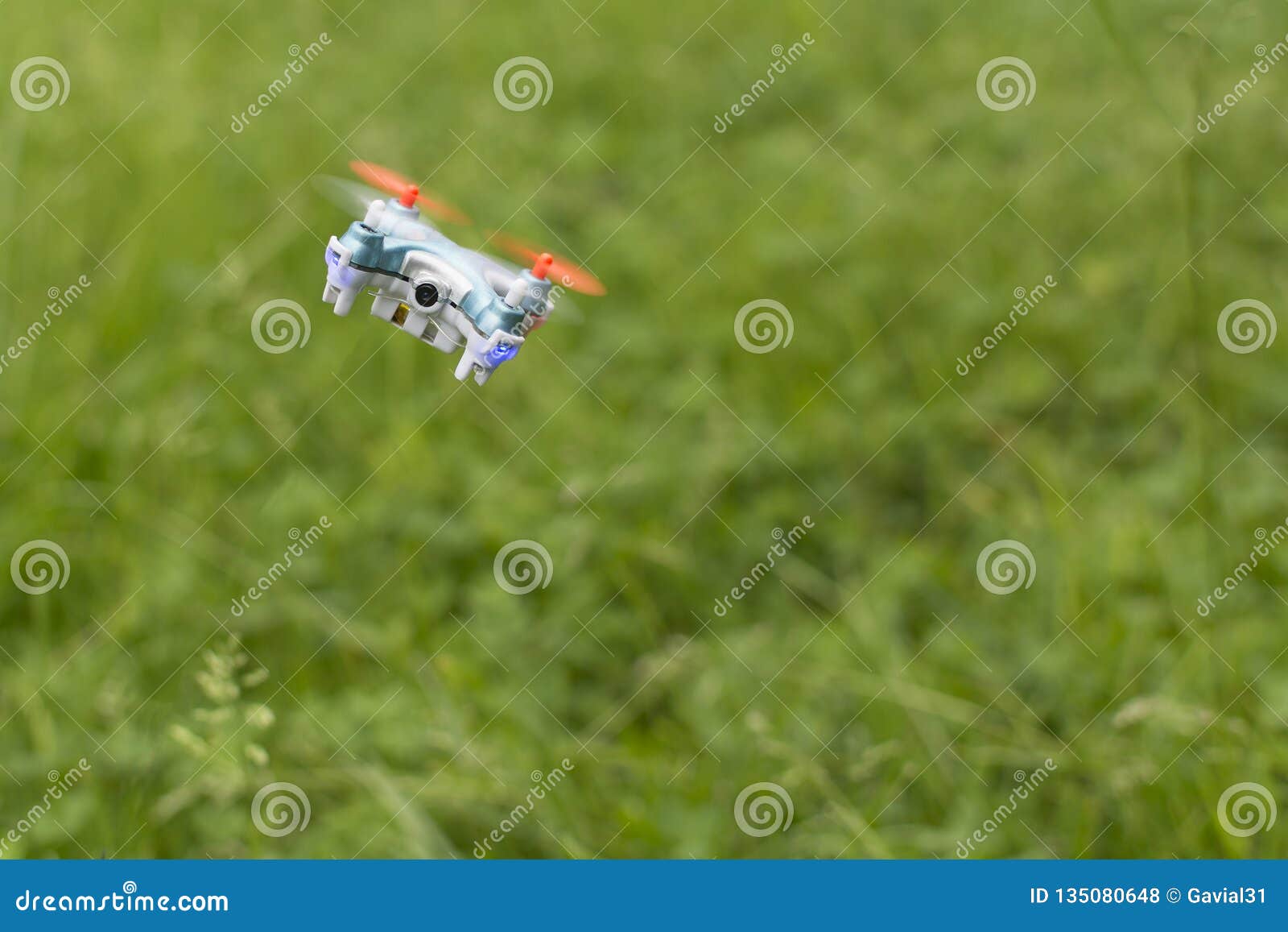 Small Drone with a Camera Flying Over the Grass Stock Photo - Image of ...