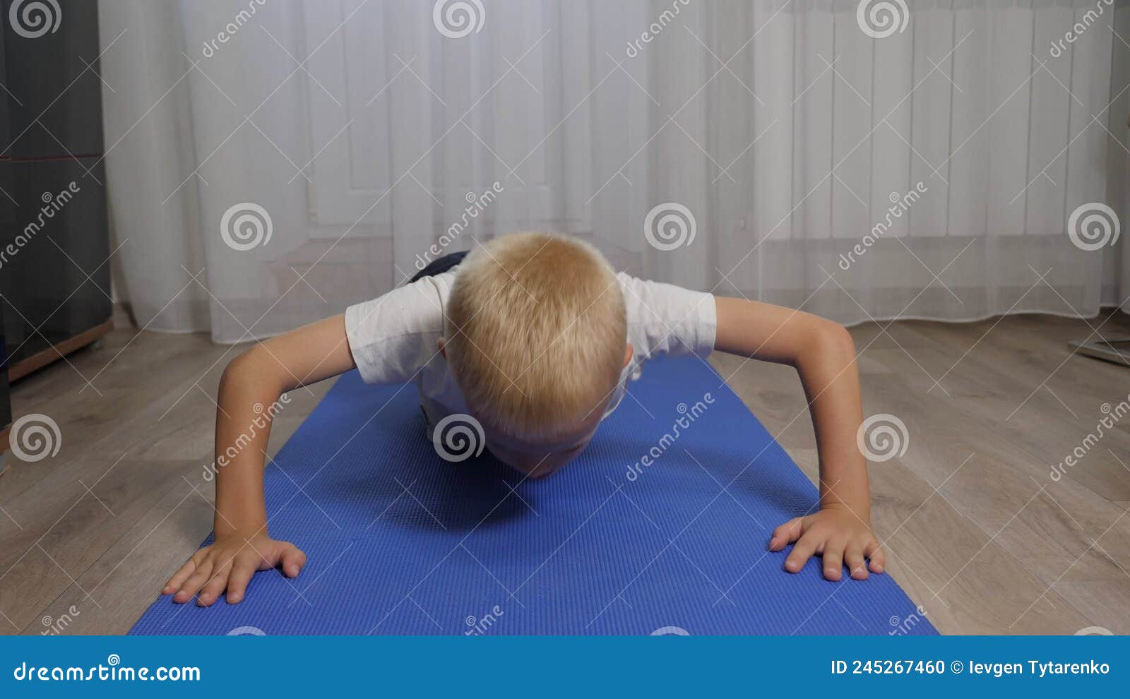 A Small Boy is Doing Push-ups from the Floor at Home, Training a Small ...