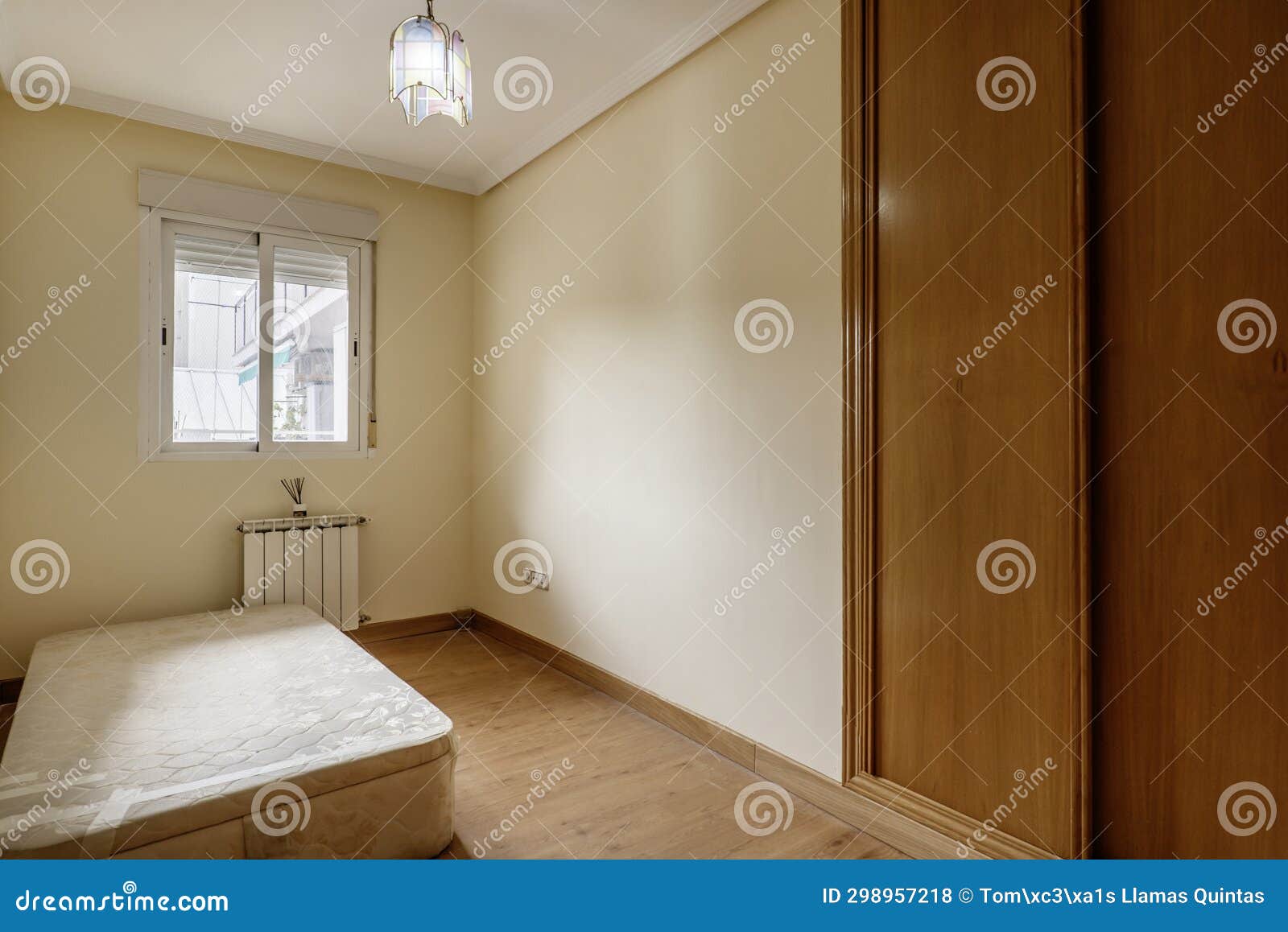 A Small Empty Room with an Old Folding Sofa and a Built-in Wardrobe ...