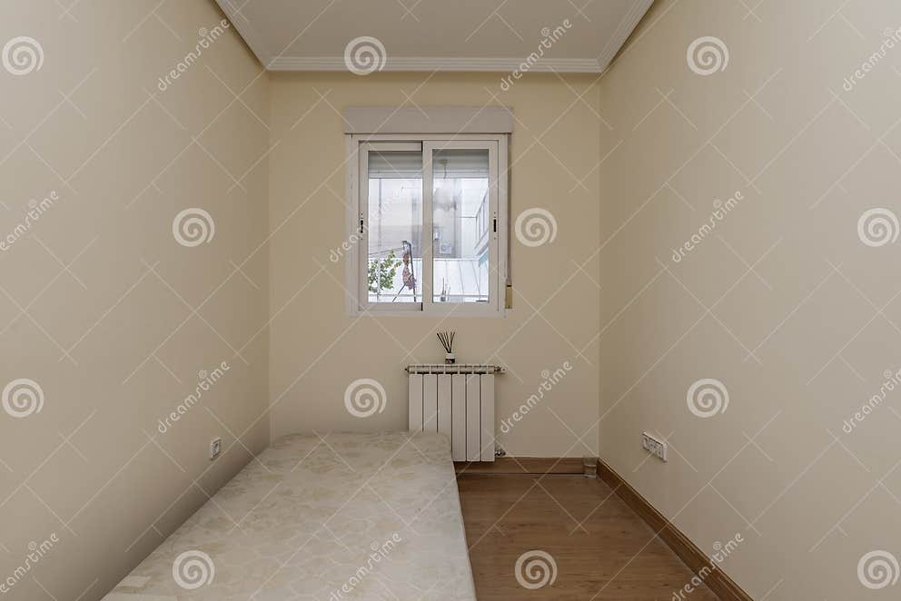 A Small Empty Room with an Old Folding Sofa and a White Aluminum ...