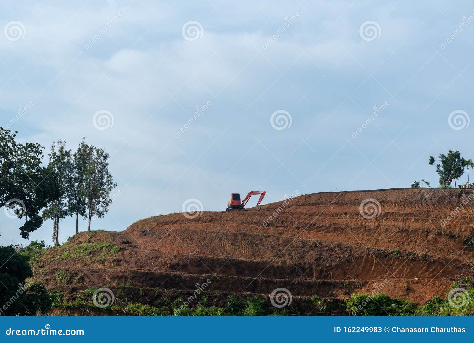 Excavator During Earthmoving Work At Construction Site On Sunset ...