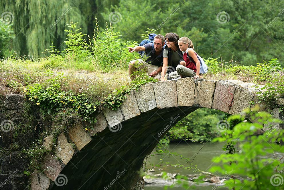 Small family on a bridge stock photo. Image of backpack - 8977894
