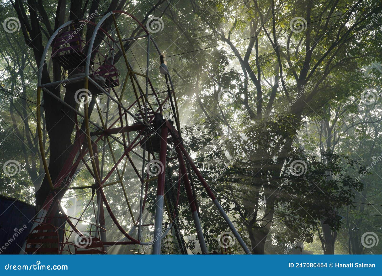 Small Ferris Wheel in the Morning Stock Photo - Image of wheel, forest ...