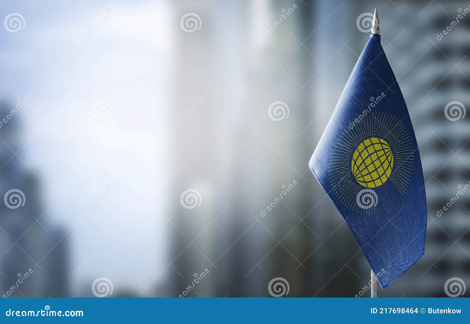 A Small Flag of Commonwealth on the Background of a Blurred Background ...