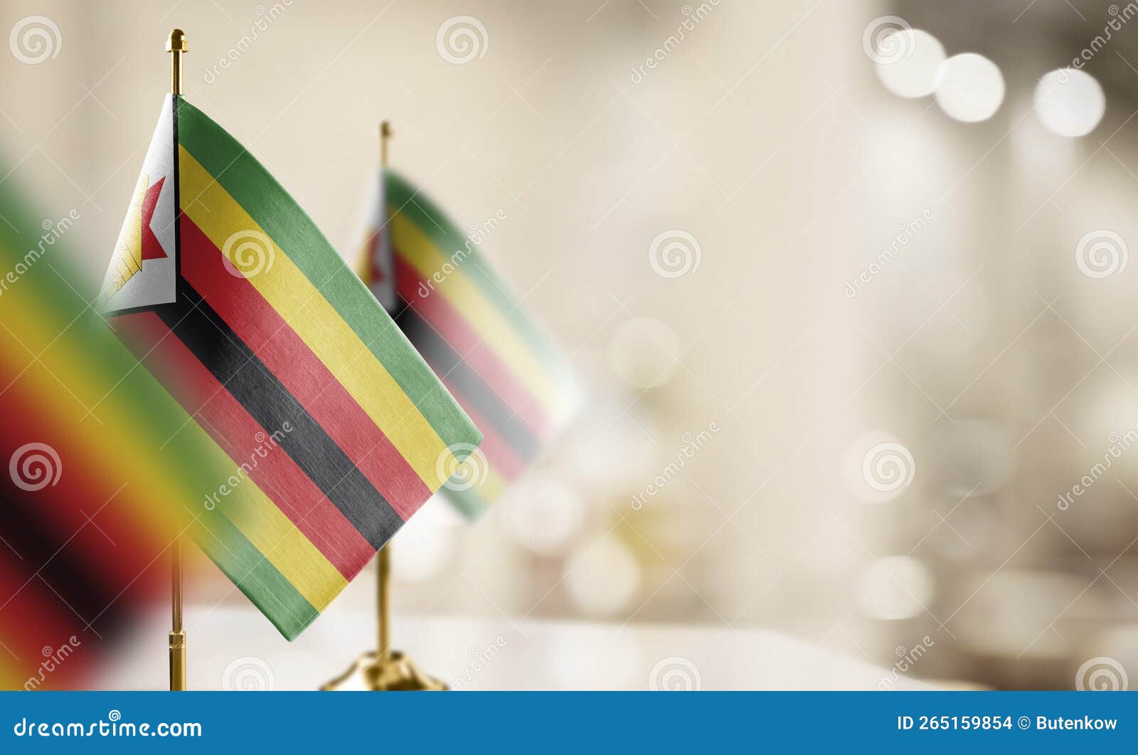 Small Flags of the Zimbabwe on an Abstract Blurry Background Stock ...