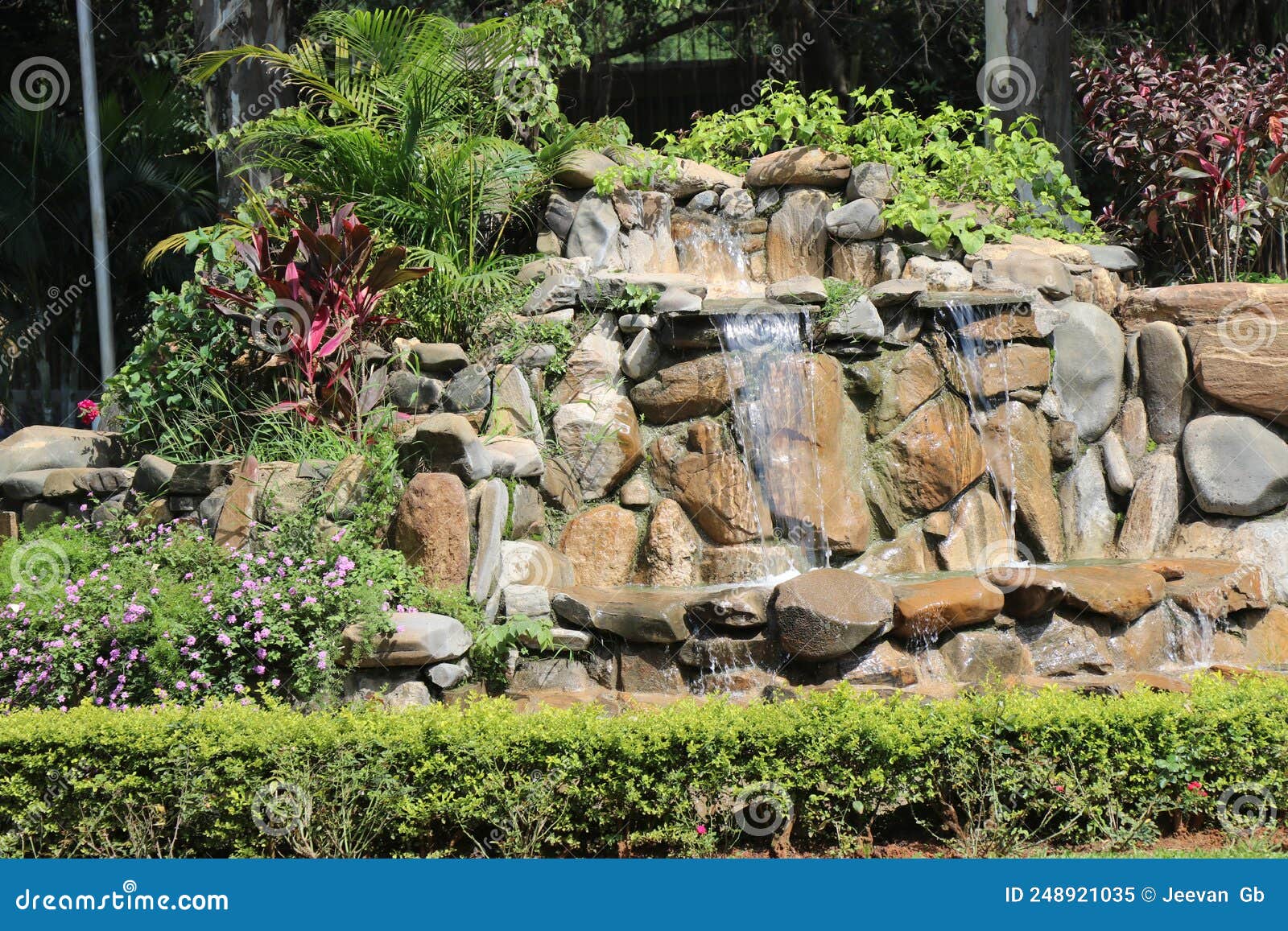 Small Garden with Water Over the Rocks on a Bright Day Filled with ...