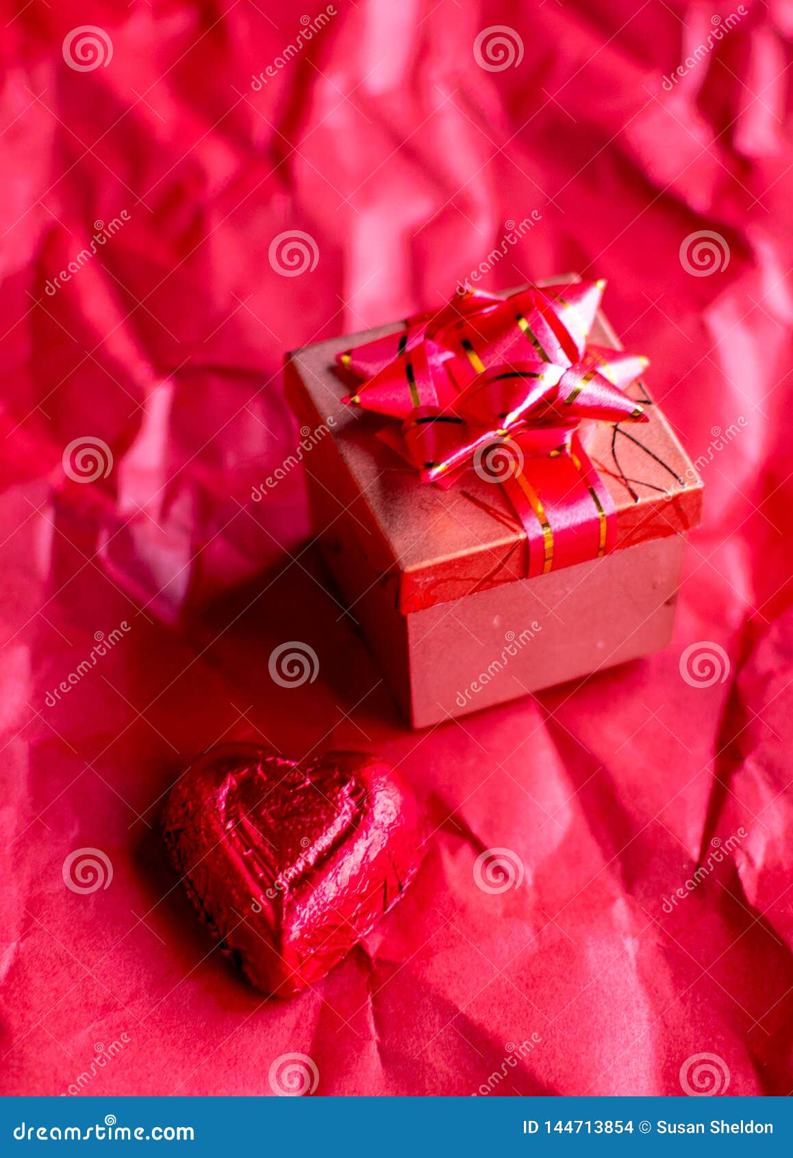Small Gift Box and a Red Foil Wrapped Heart Stock Photo - Image of ...