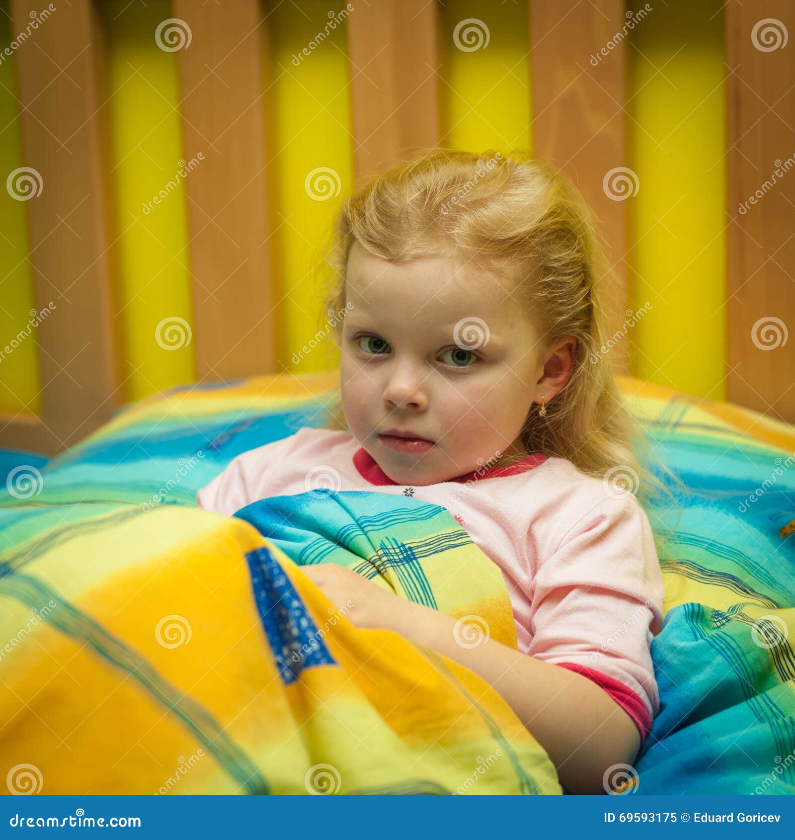Small Girl in Sheets on a Wooden Bed Stock Image - Image of candid ...