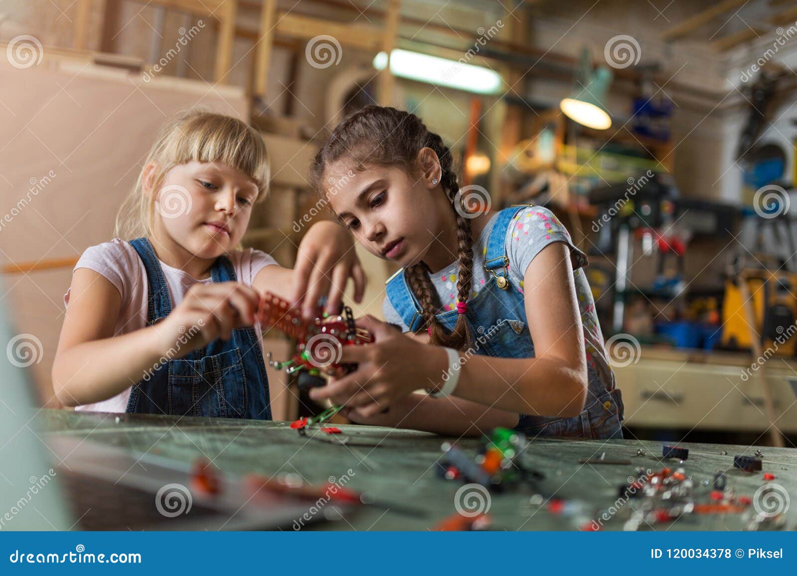 Young Girls Building Toy Construction Machine Stock Photo - Image of ...