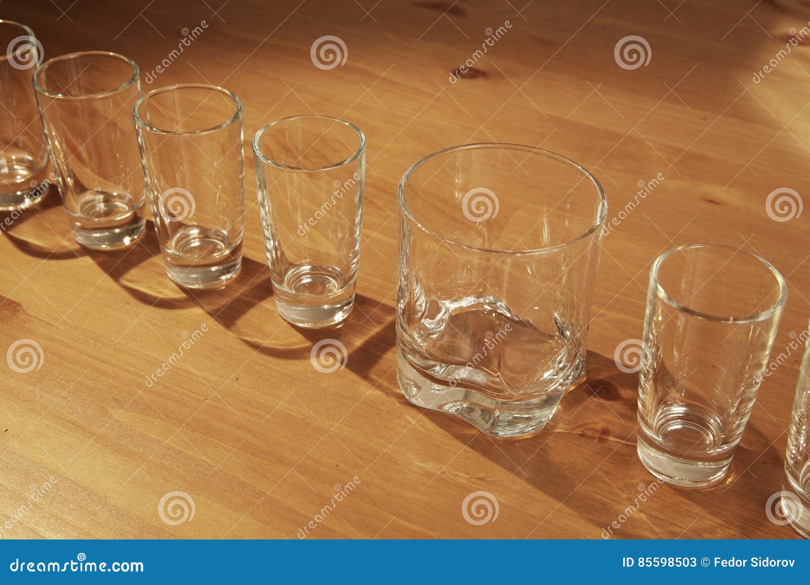 Small Glasses and a Big One Stock Image - Image of dishware, aligned ...