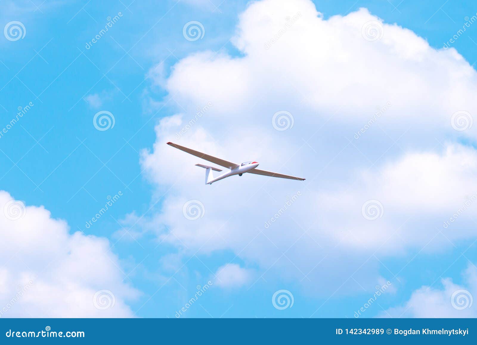 Small Glider Flying Against the Blue Sky and Clouds Stock Image - Image ...