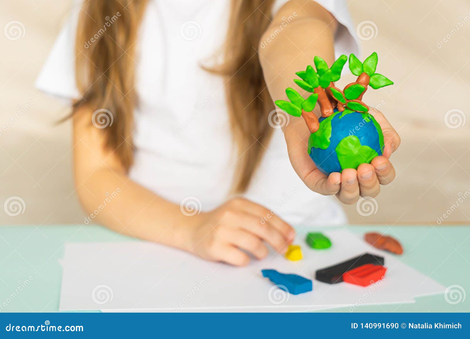 A Small Globe with Trees in the Hands of a Child. Layout of the Planet ...