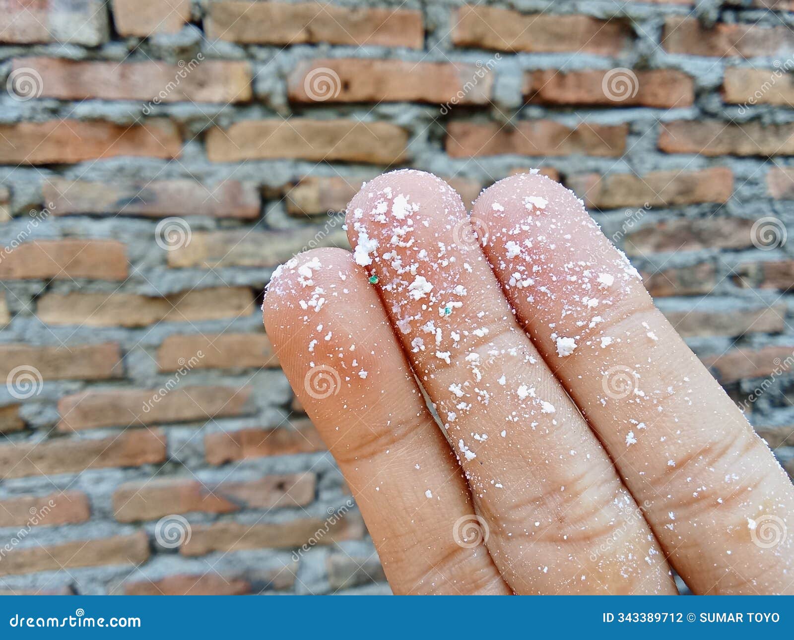 Small Granules of Microplastic Stuck between the Fingers Stock Photo ...