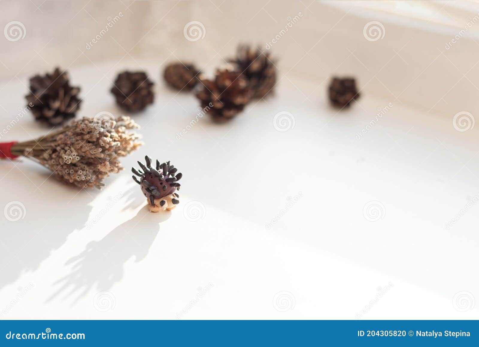 A Small Hedgehog Made of Clay with Needles on a Light Background. Shadi ...