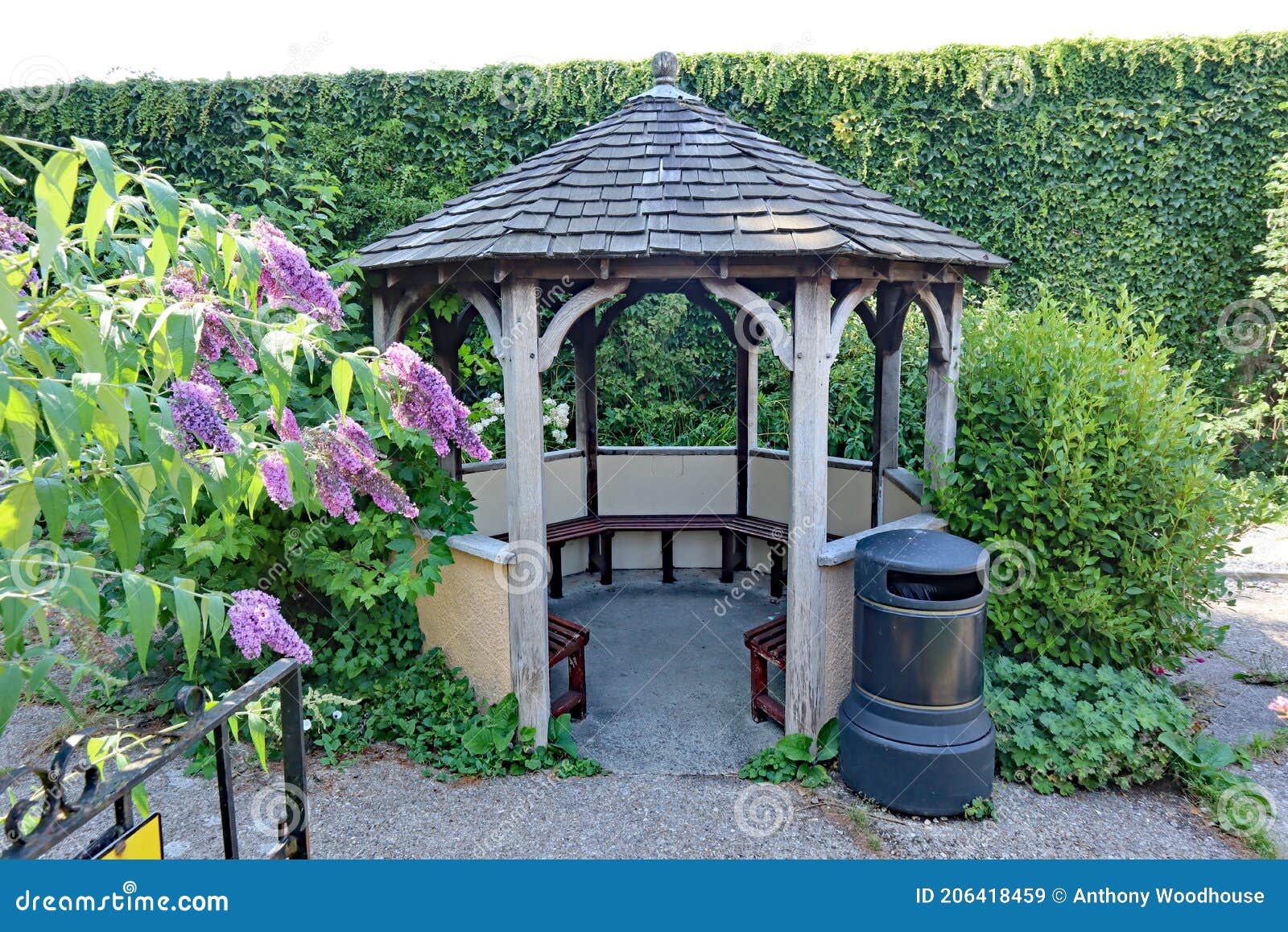 A Small Hexagonal Gazebo with a Tiled Roof in Tiny Public Space in ...