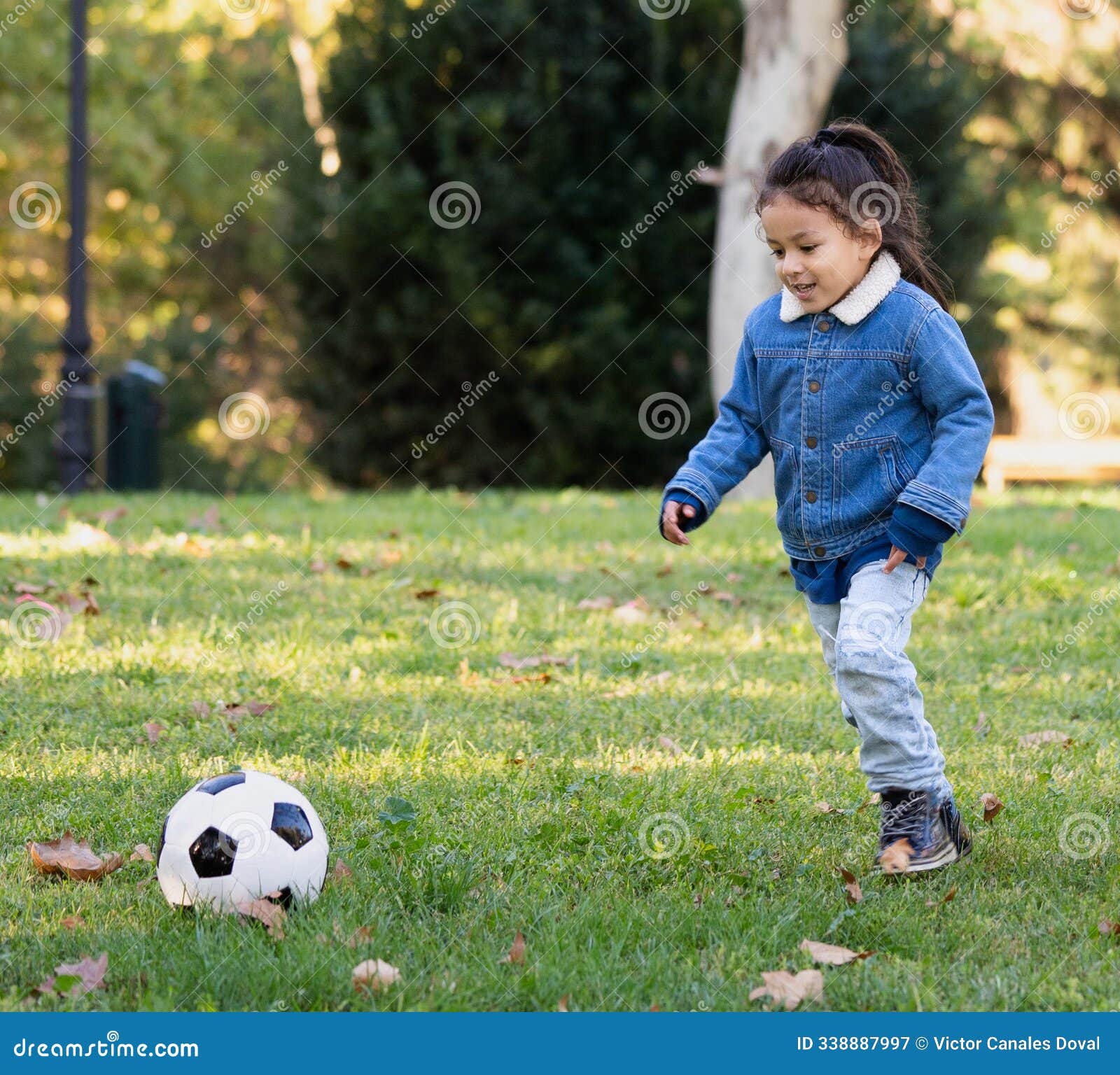 Small Hispanic Boy Playing in a Park with a Soccer Ball in Autumn Stock ...