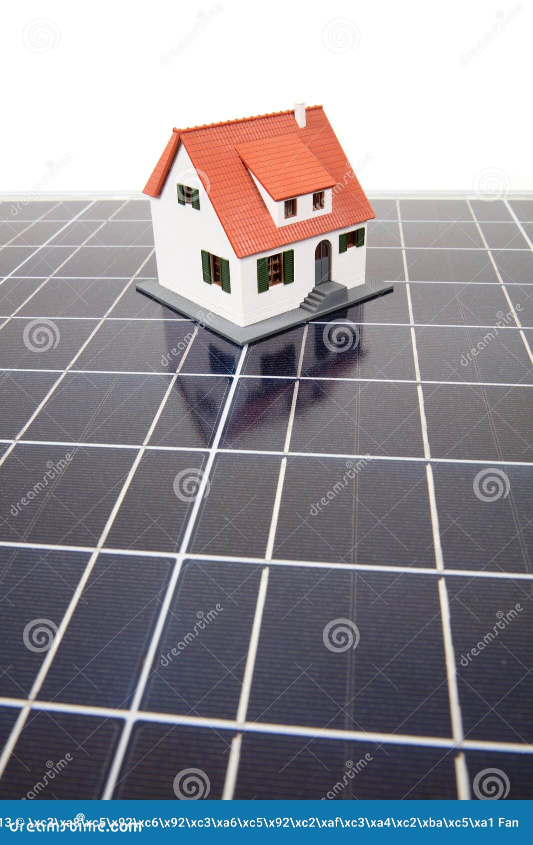 A Small House Model on Solar Panels in Front of White Background Stock ...