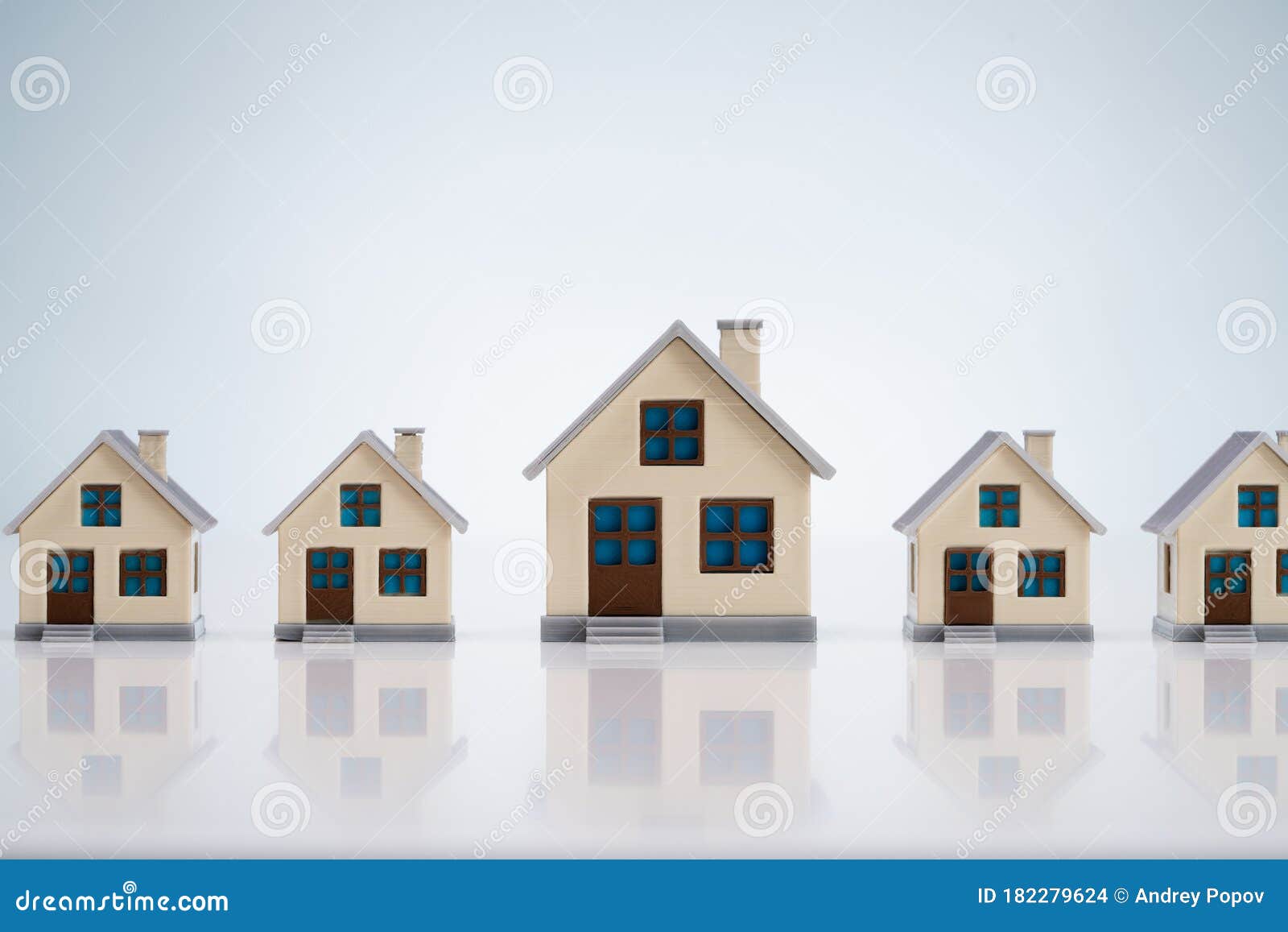 Small House Models Arranged in Row Over Table Stock Photo - Image of ...