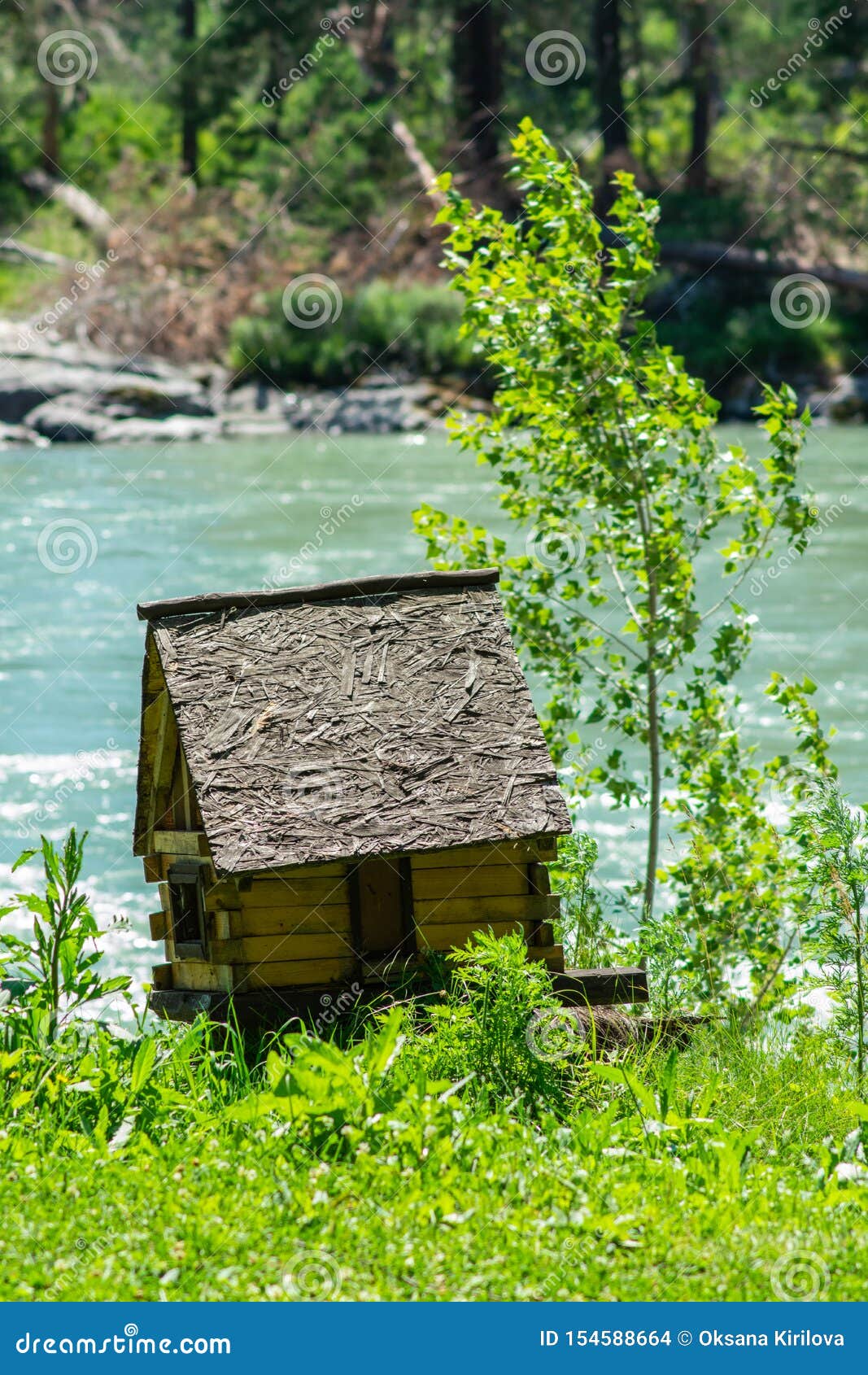 A small house by the river stock photo. Image of garden - 154588664